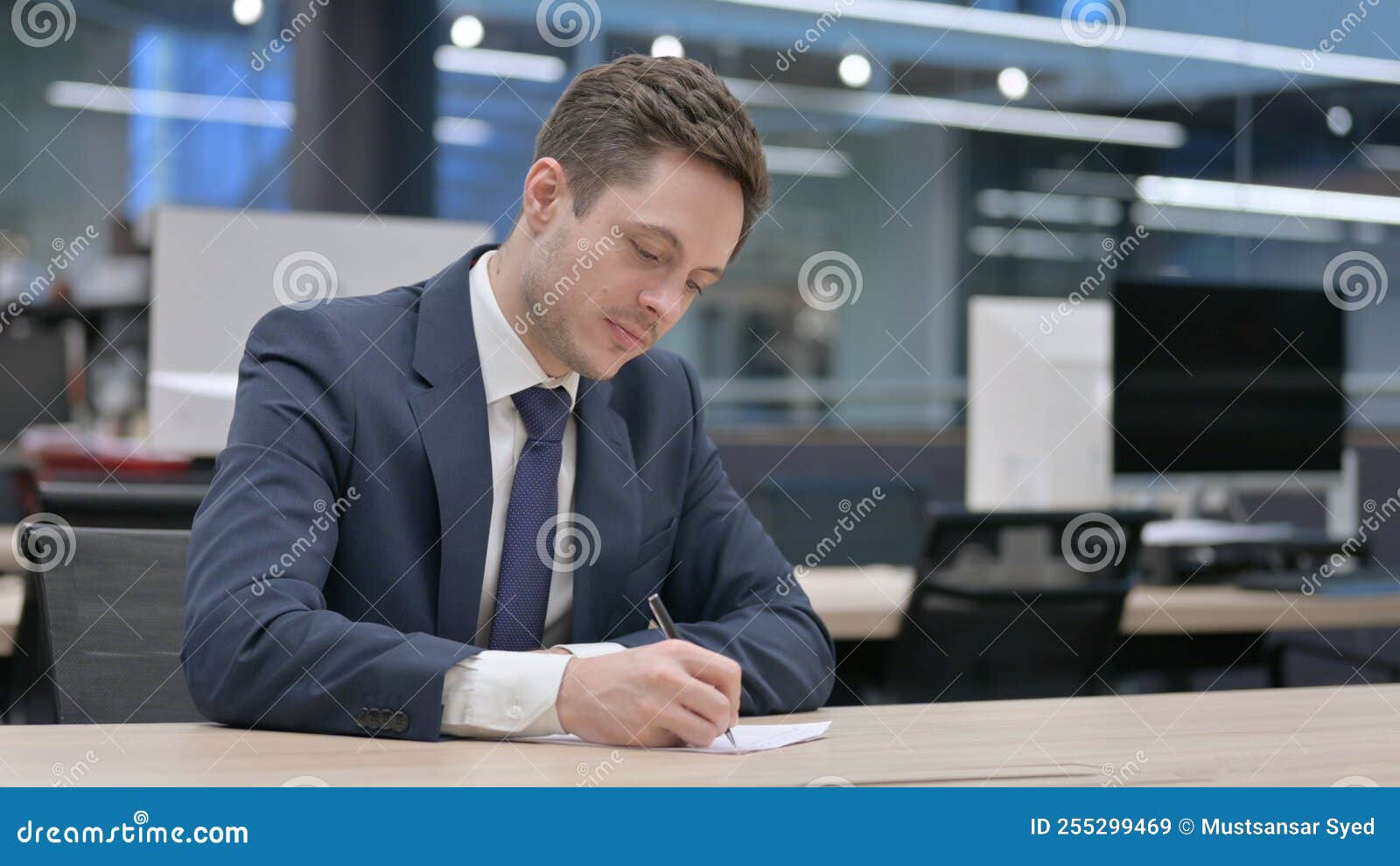 Businessman Writing on Paper in Office Stock Image - Image of journal ...
