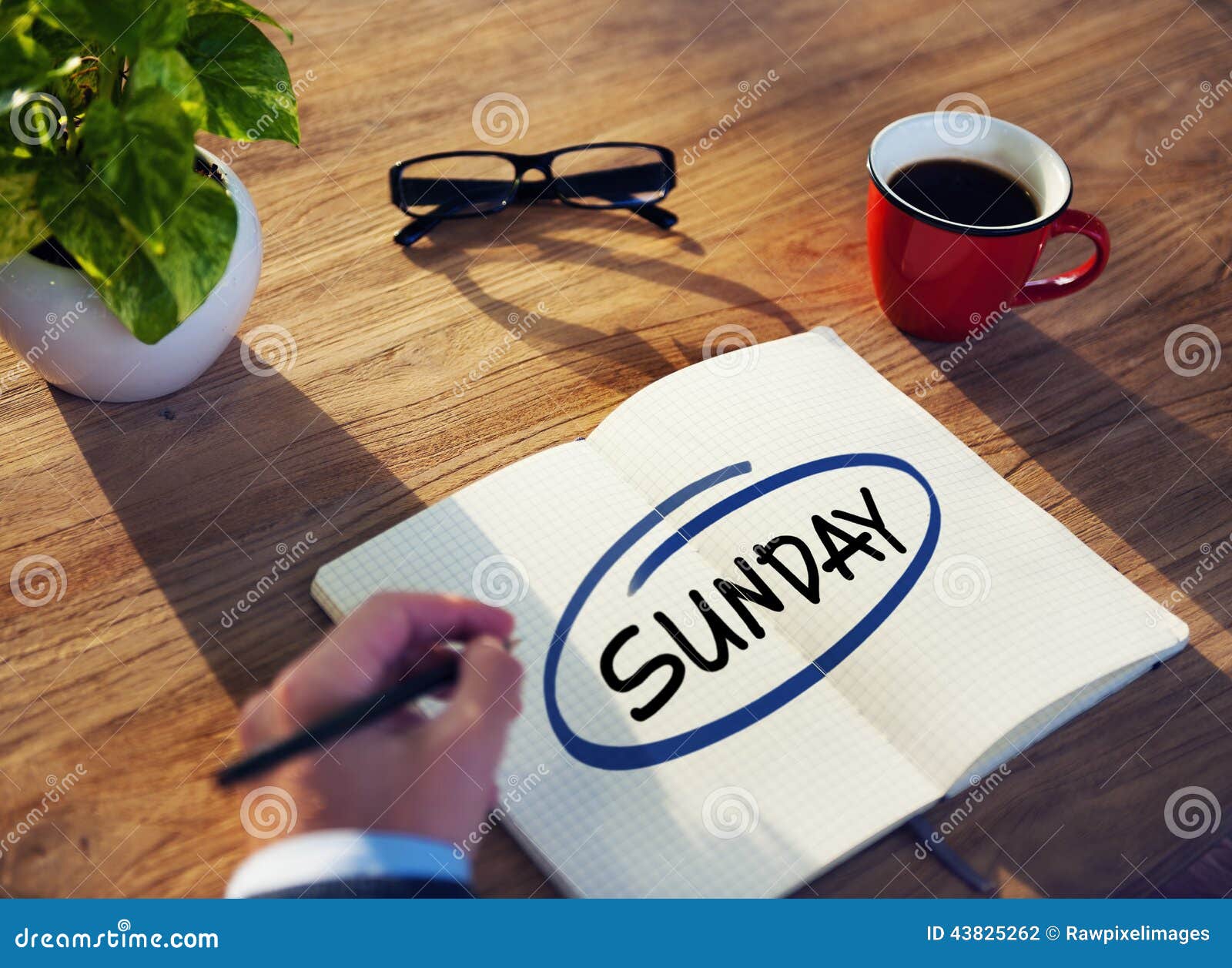 Businessman Writing the Word Sunday on Note Pad Stock Photo - Image of ...
