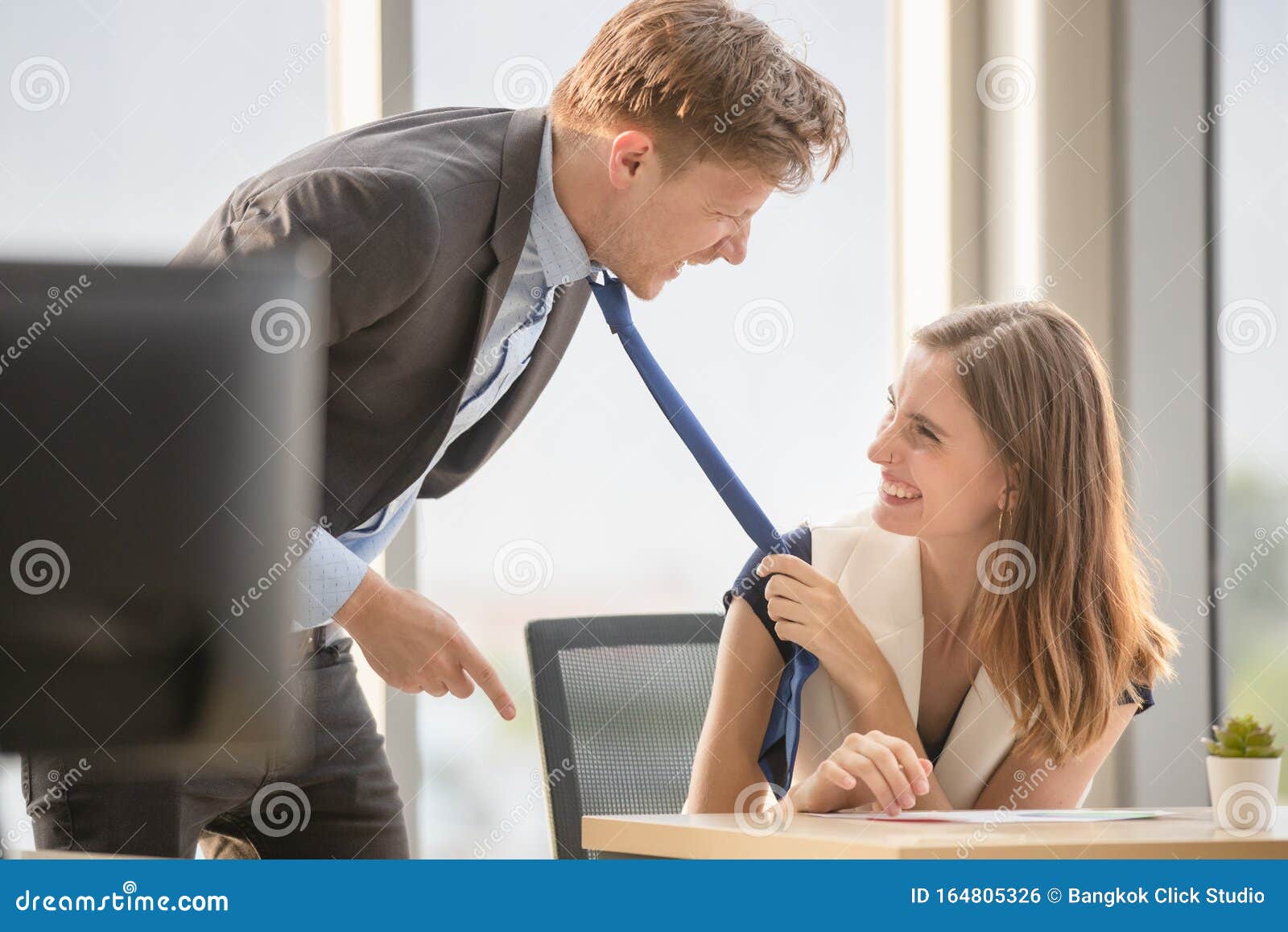 Businessman and Young Businesswoman Smiling and Laughing Happily in the ... Businessman and Young Businesswoman Smiling and Laughing Happily in the ...