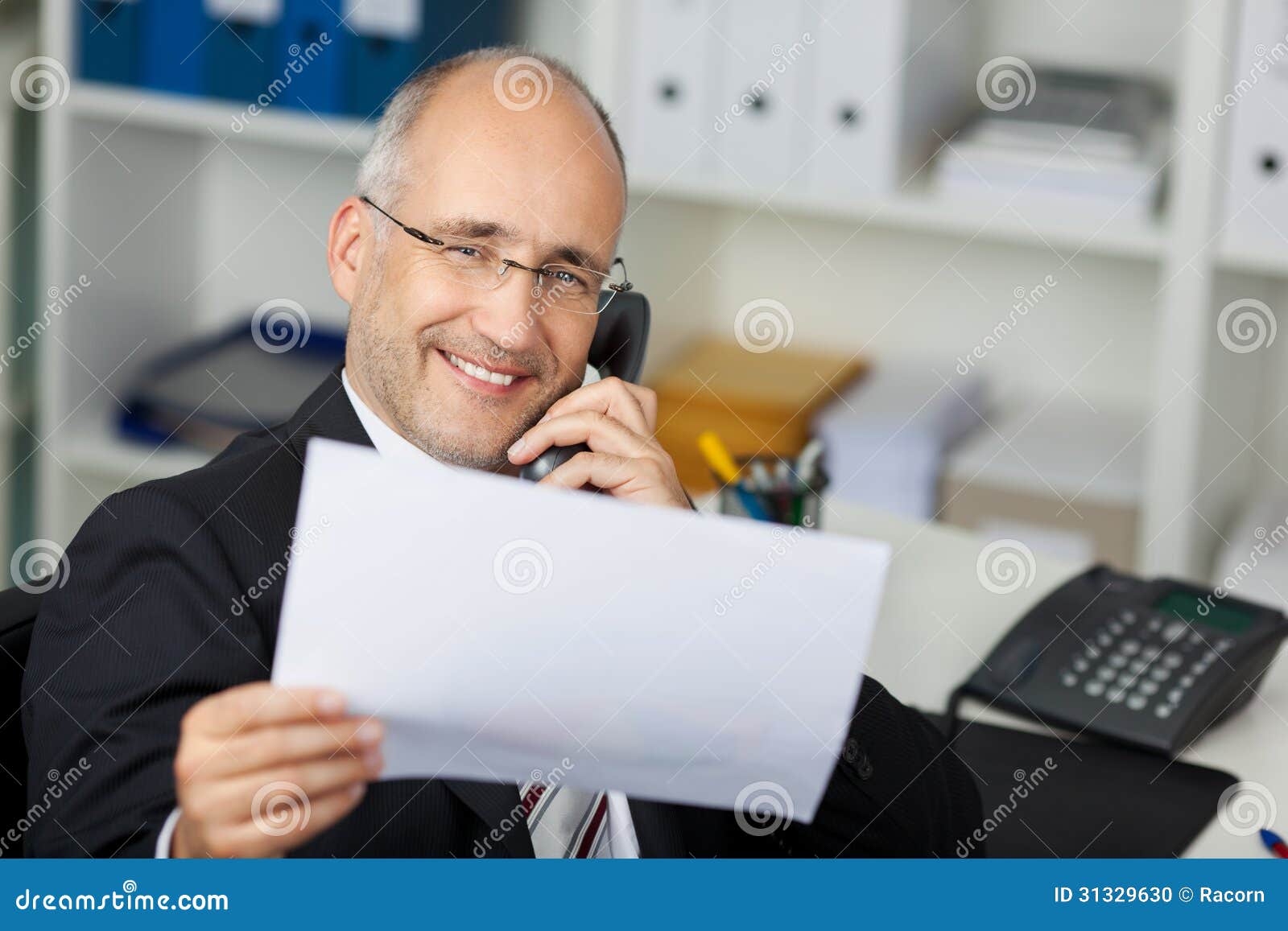 Businessmann Reading Document while Calling Stock Photo - Image of ...