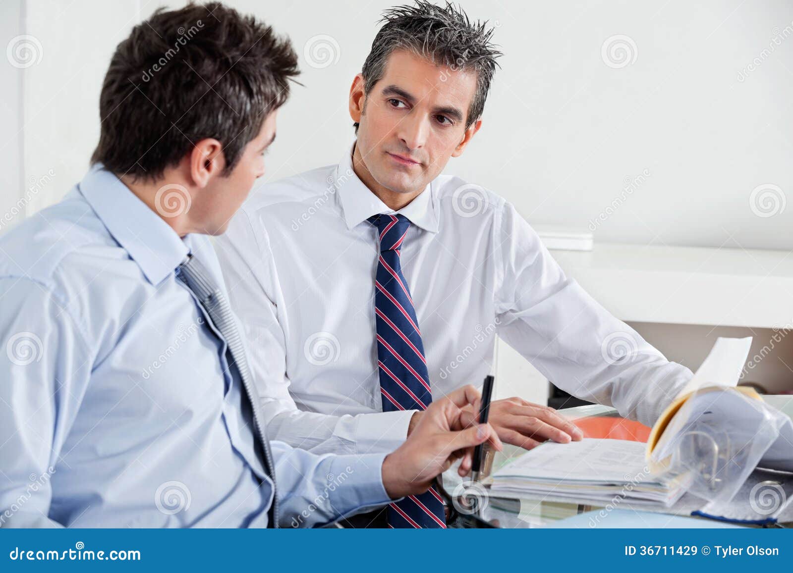 Businessmen Discussing Paperwork in Office Stock Image - Image of ...
