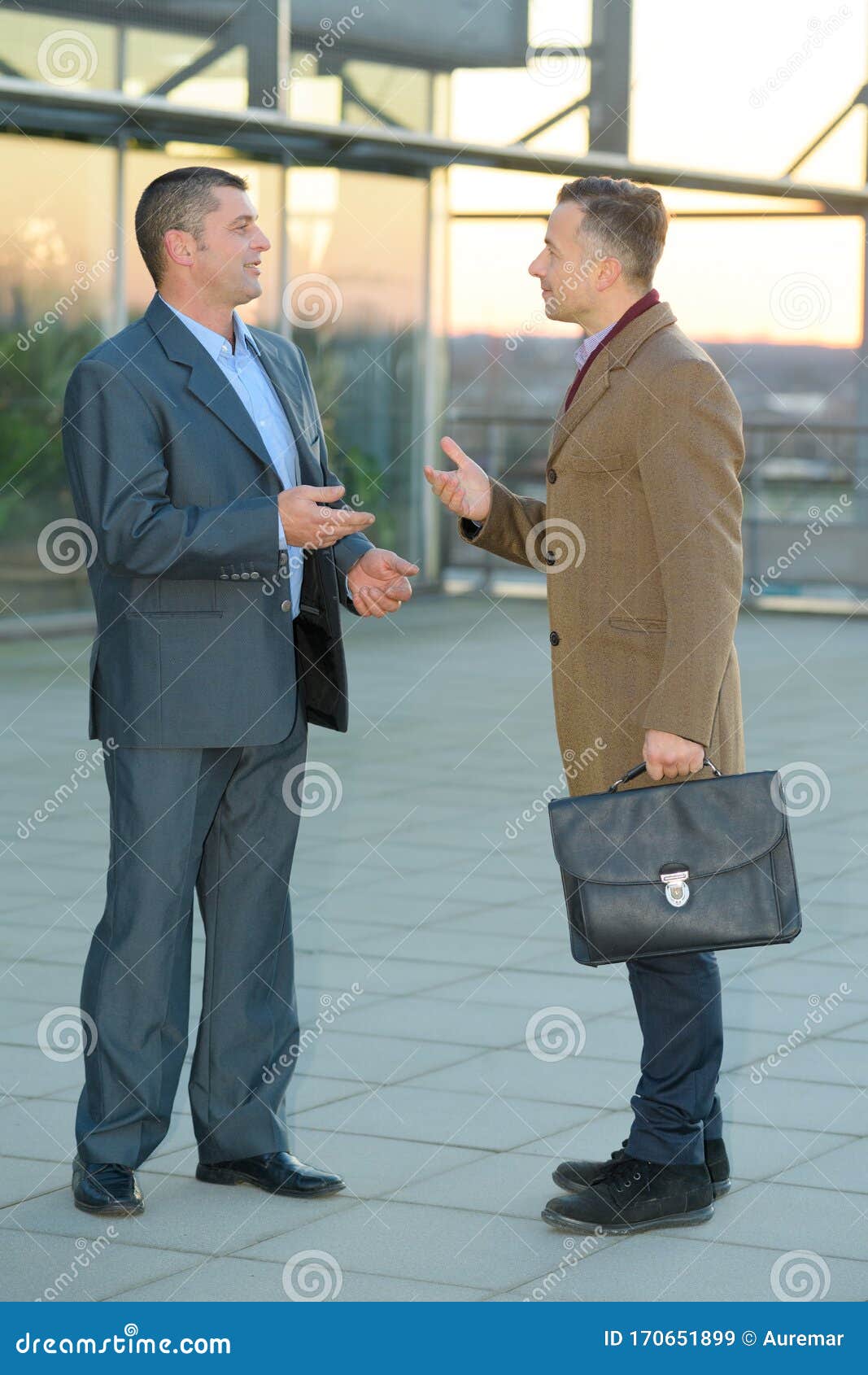 Businessmen in Discussion Outside Work Premises Stock Image - Image of ...