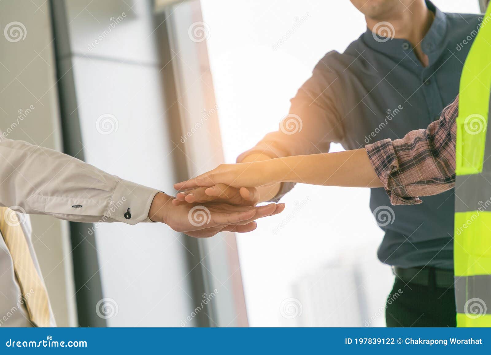 Businessmen and Engineers Stack Hands of Teamwork Join Together To ...