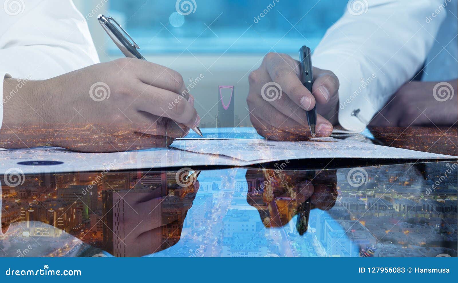 Businessmen Hands Signing Documents on Riyadh Skyline City Scape ...