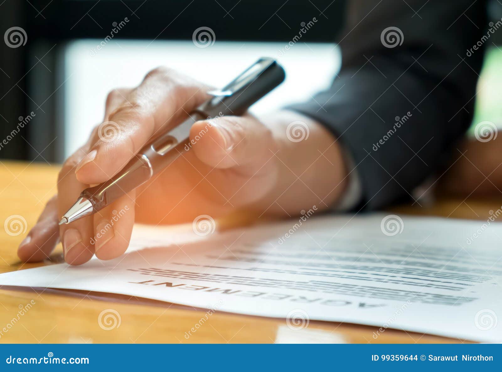 Businessmen Holding Pens in Hand Reading Documents on the Desk ... Businessmen Holding Pens in Hand Reading Documents on the Desk ...