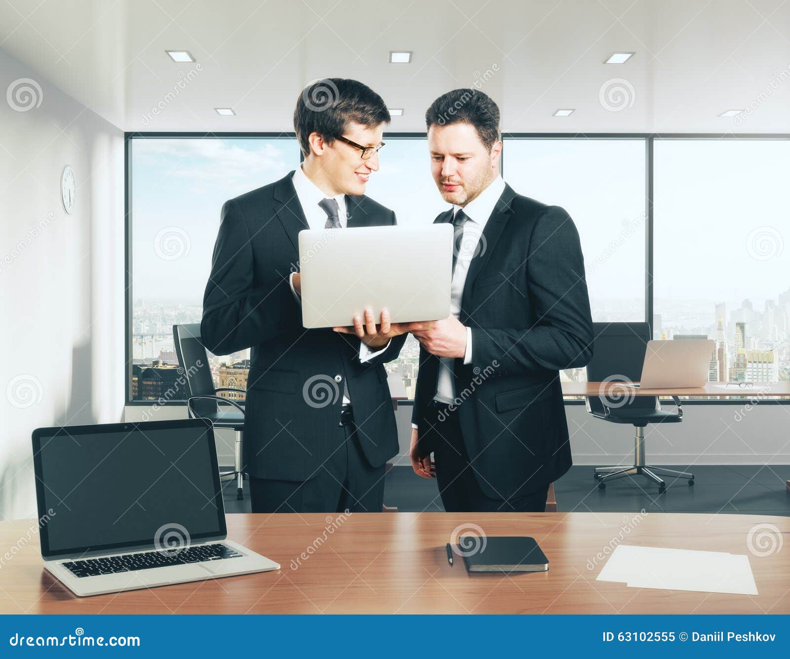 Businessmen with Laptop Discussing Something in the Office Stock Image ...