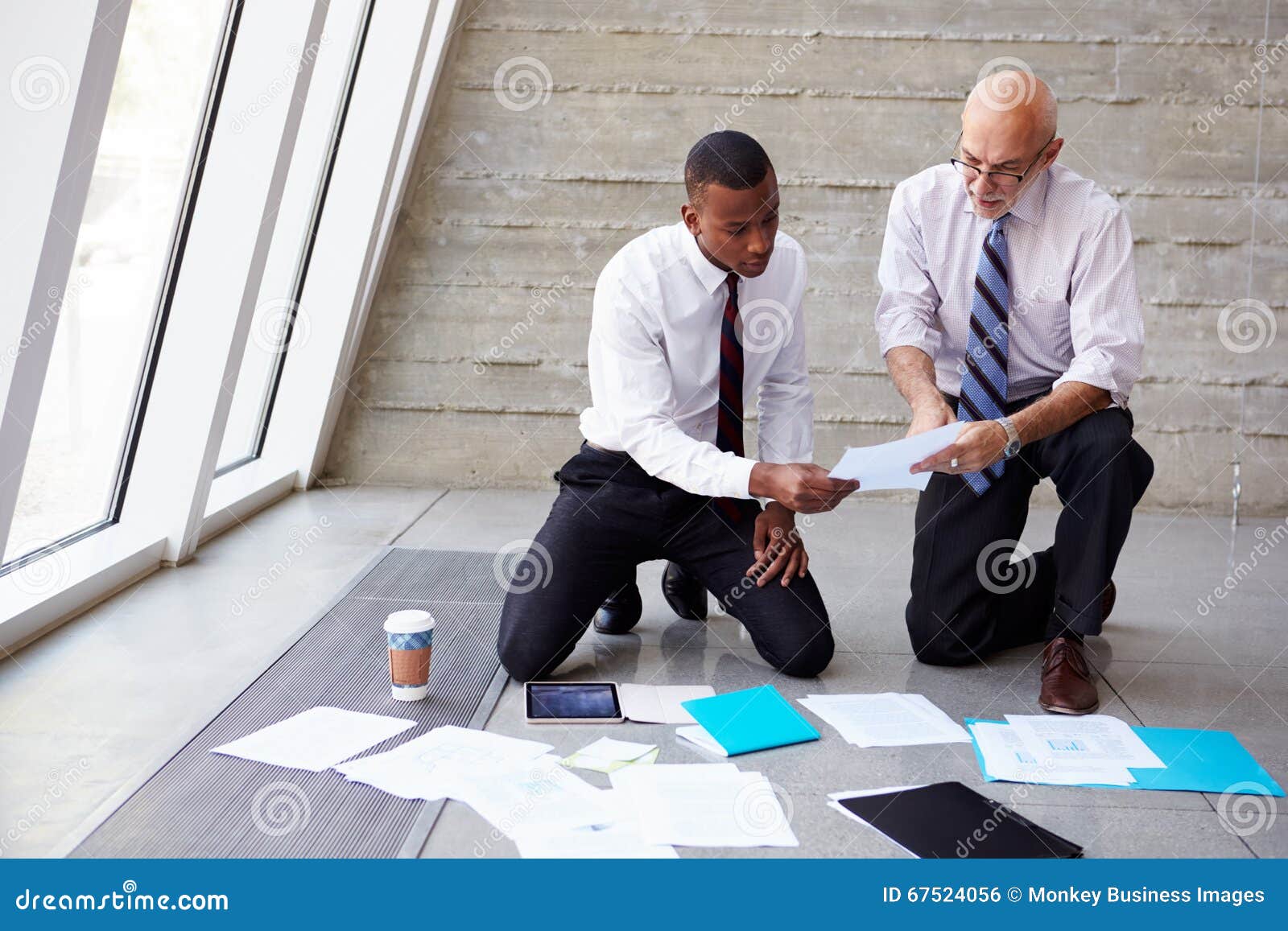Businessmen Laying Documents on Floor To Plan Project Stock Photo ...