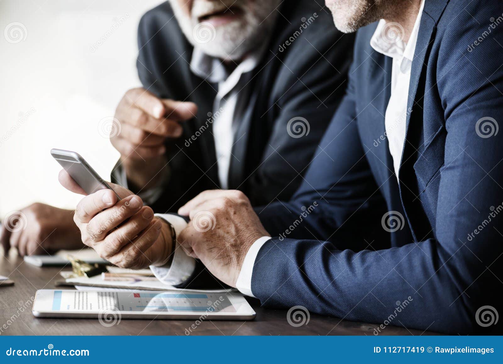Businessmen Looking Information on Electronic Device Stock Image ...
