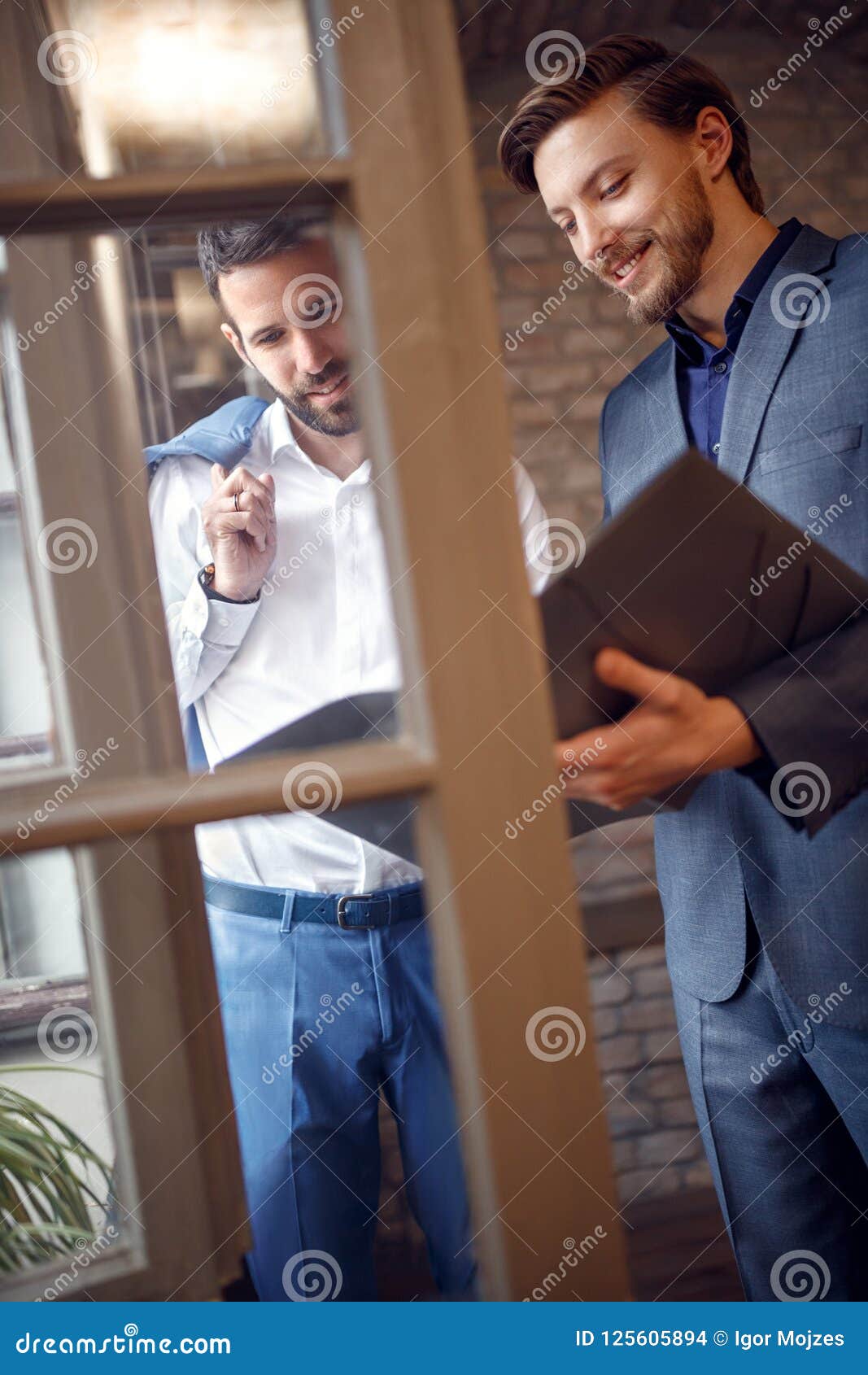 Businessmen in Office Considering Business Plan Stock Photo - Image of ...