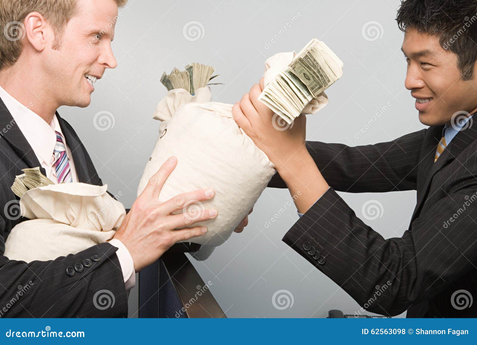 Businessmen passing money stock photo. Image of indoors - 62563098