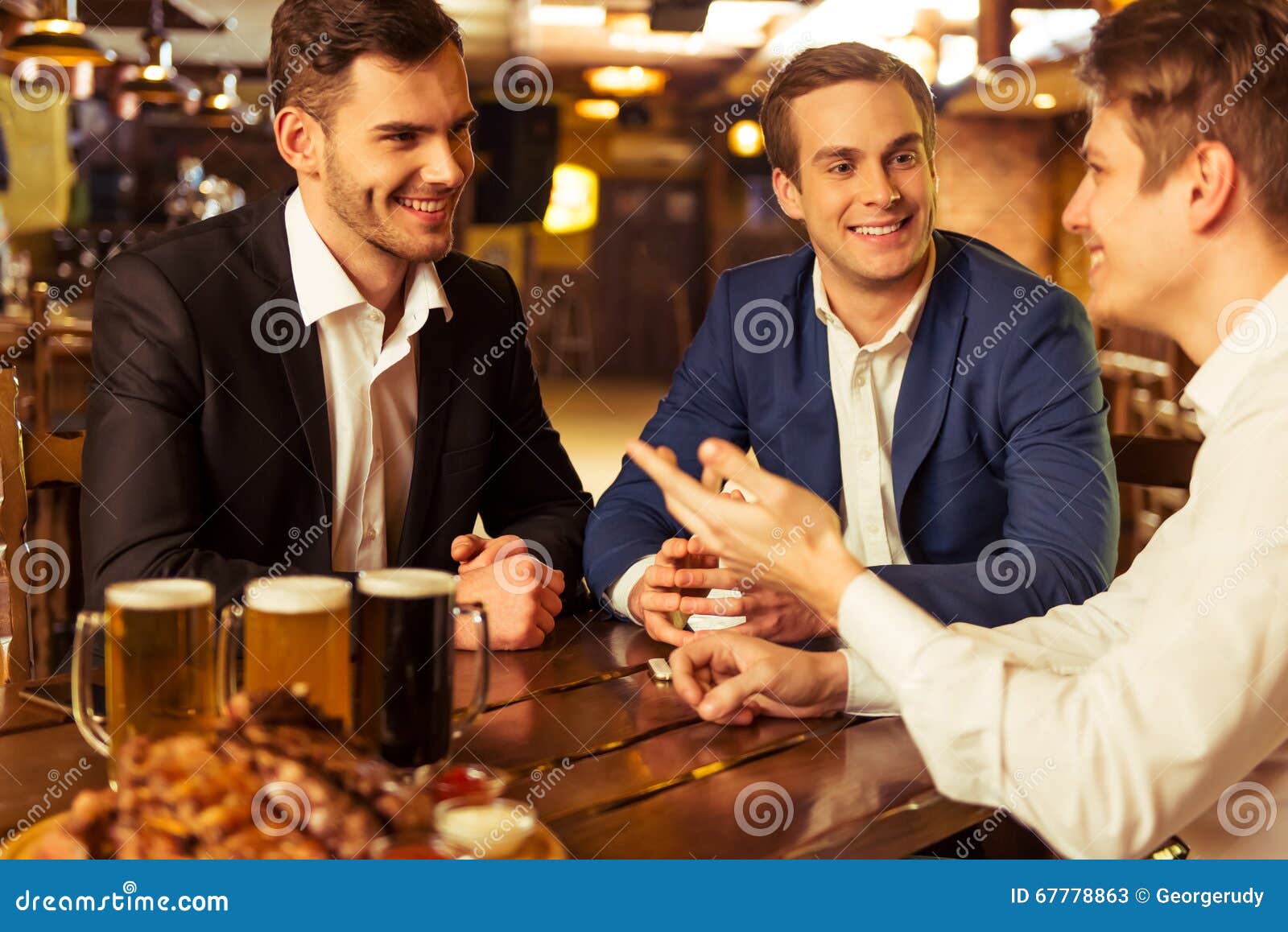 Businessmen in pub stock image. Image of attractive, glass - 67778863