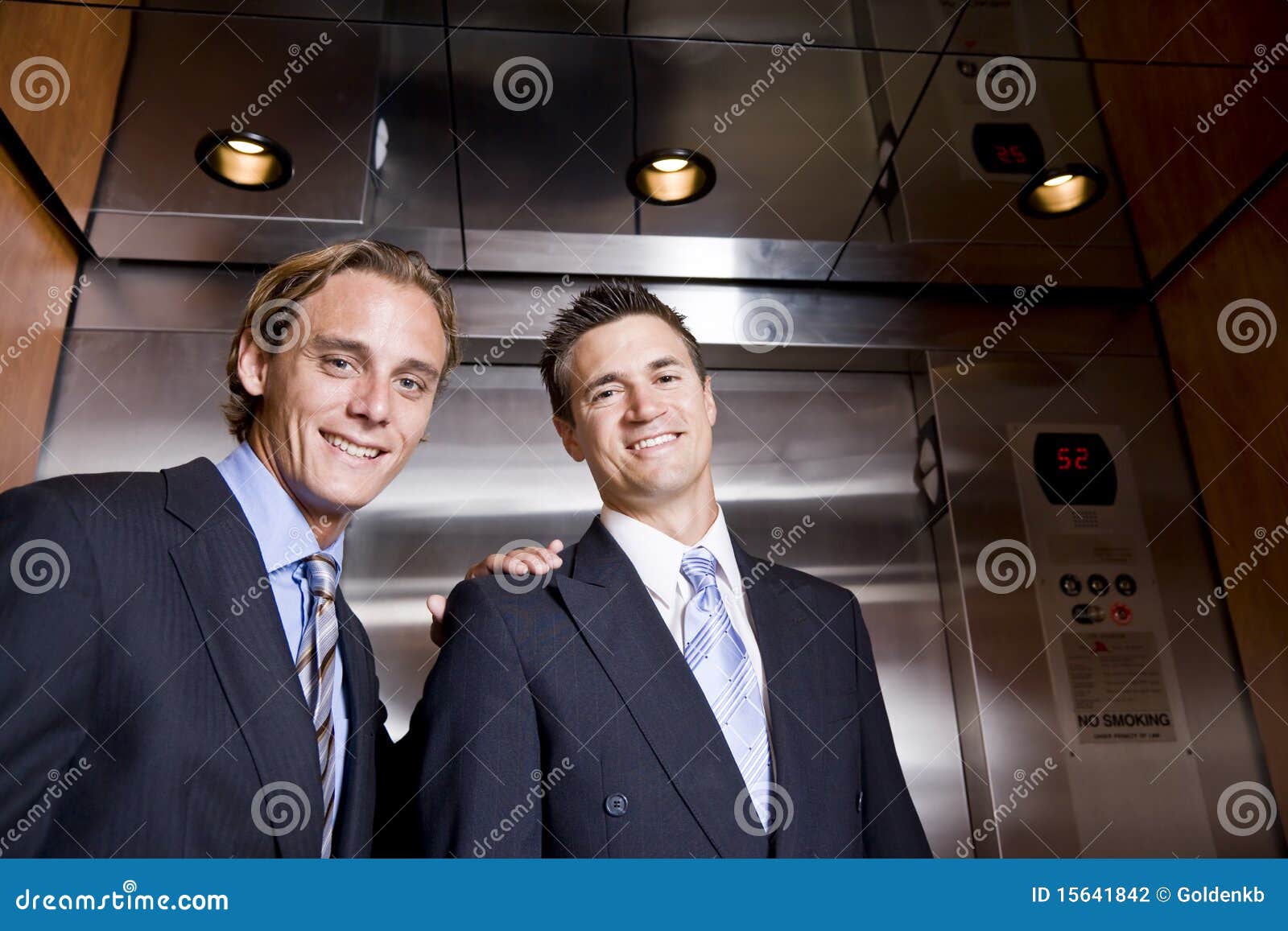 Businessmen Riding in Elevator Stock Photo - Image of business ...