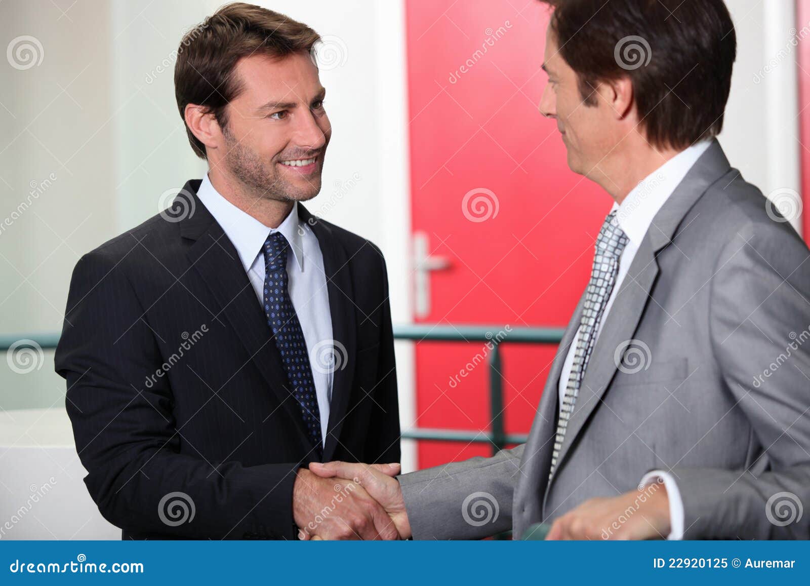 Businessmen shaking hands stock image. Image of male - 22920125