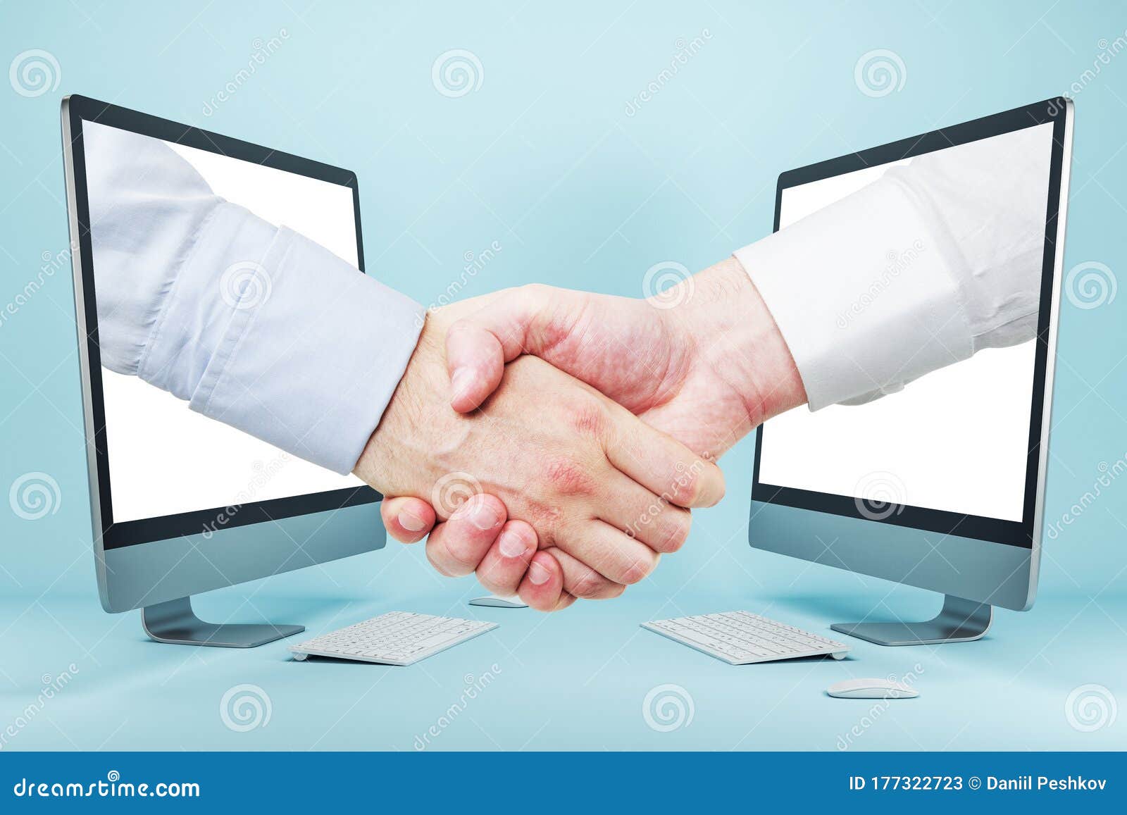 Businessmen Shaking Hands through Computer Screens on Blue Background ...
