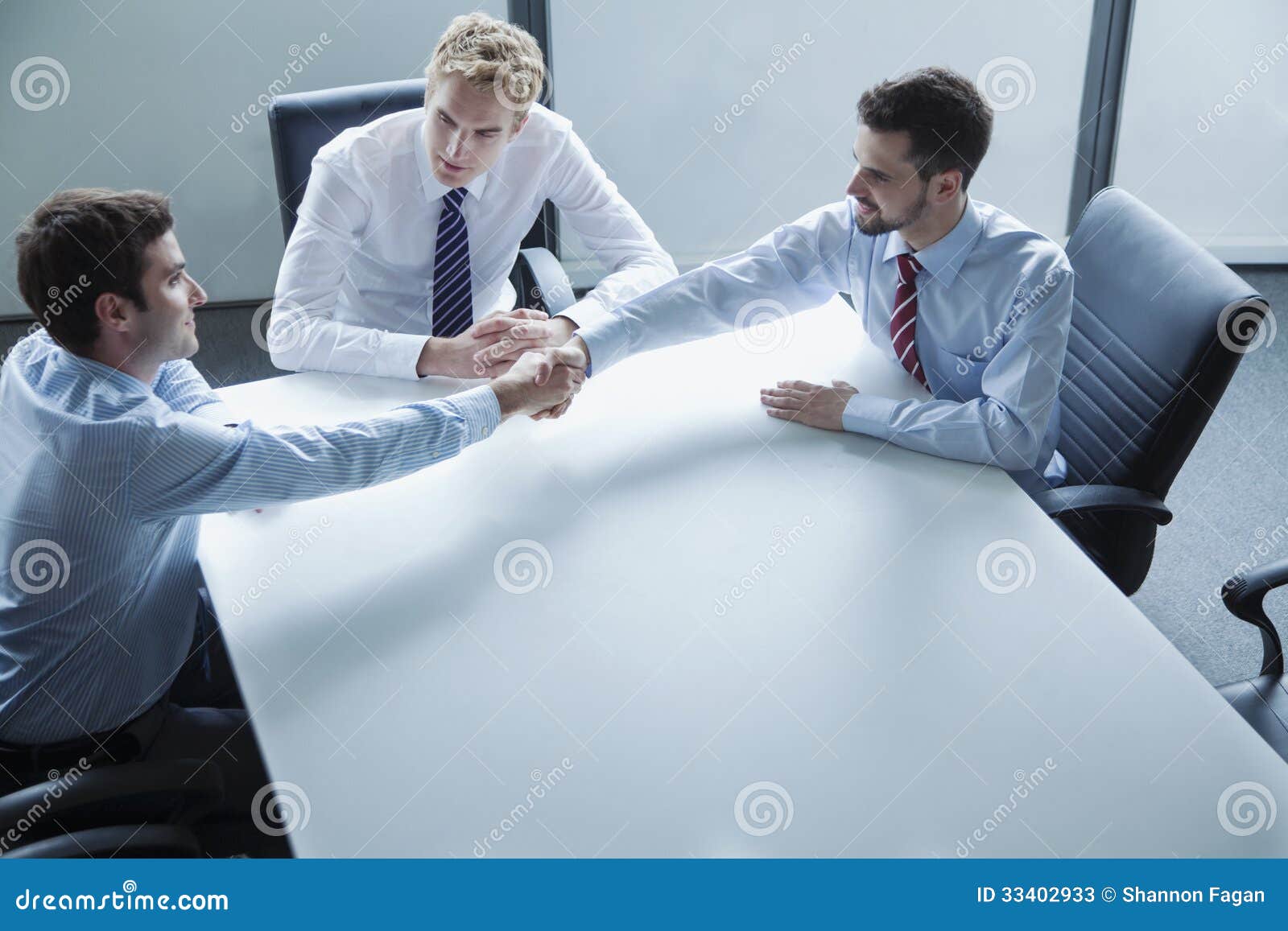 Businessmen Shaking Hands Over the Table in the Office Stock Image ...