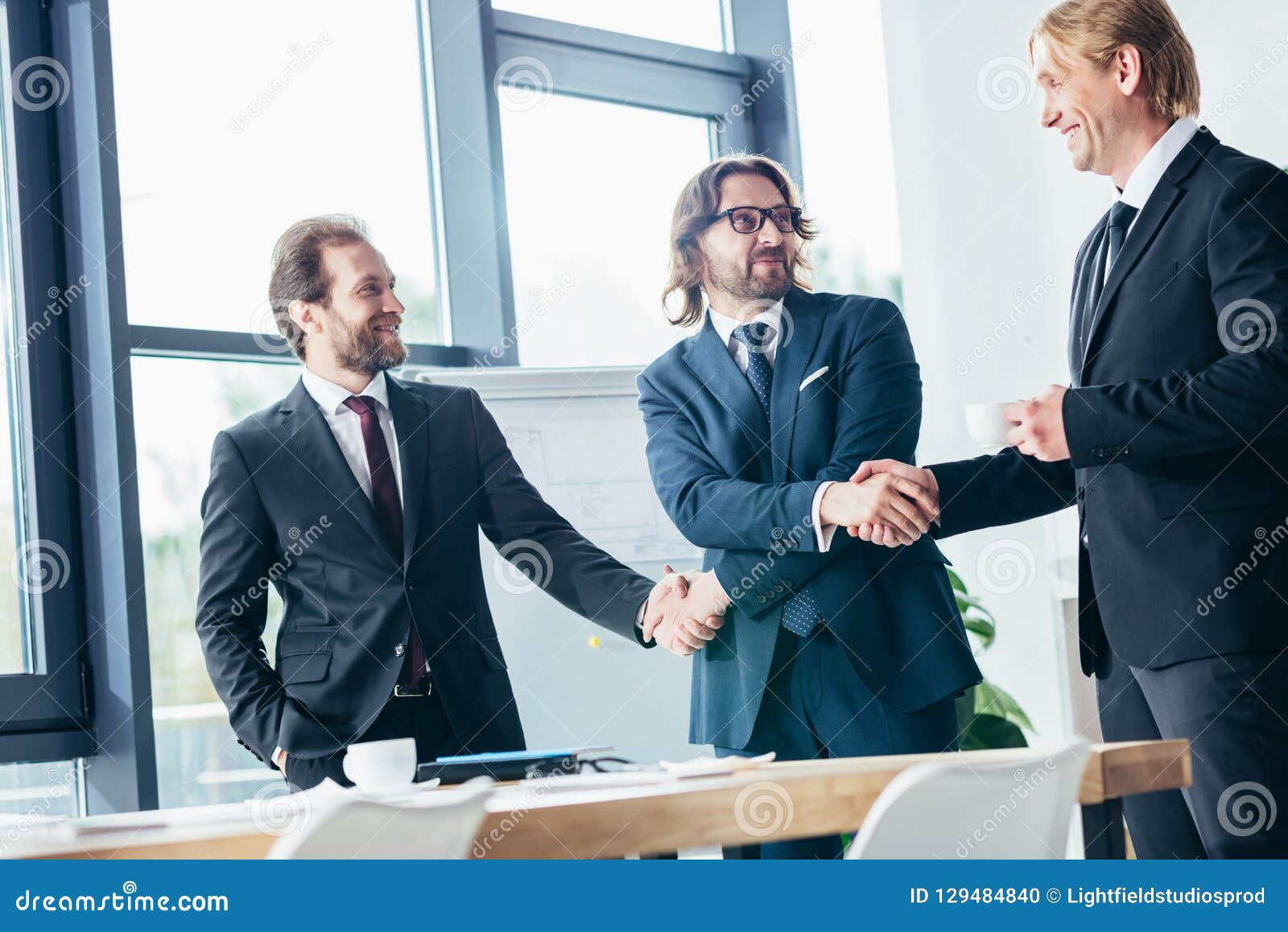 Businessmen shaking hands stock photo. Image of career - 129484840