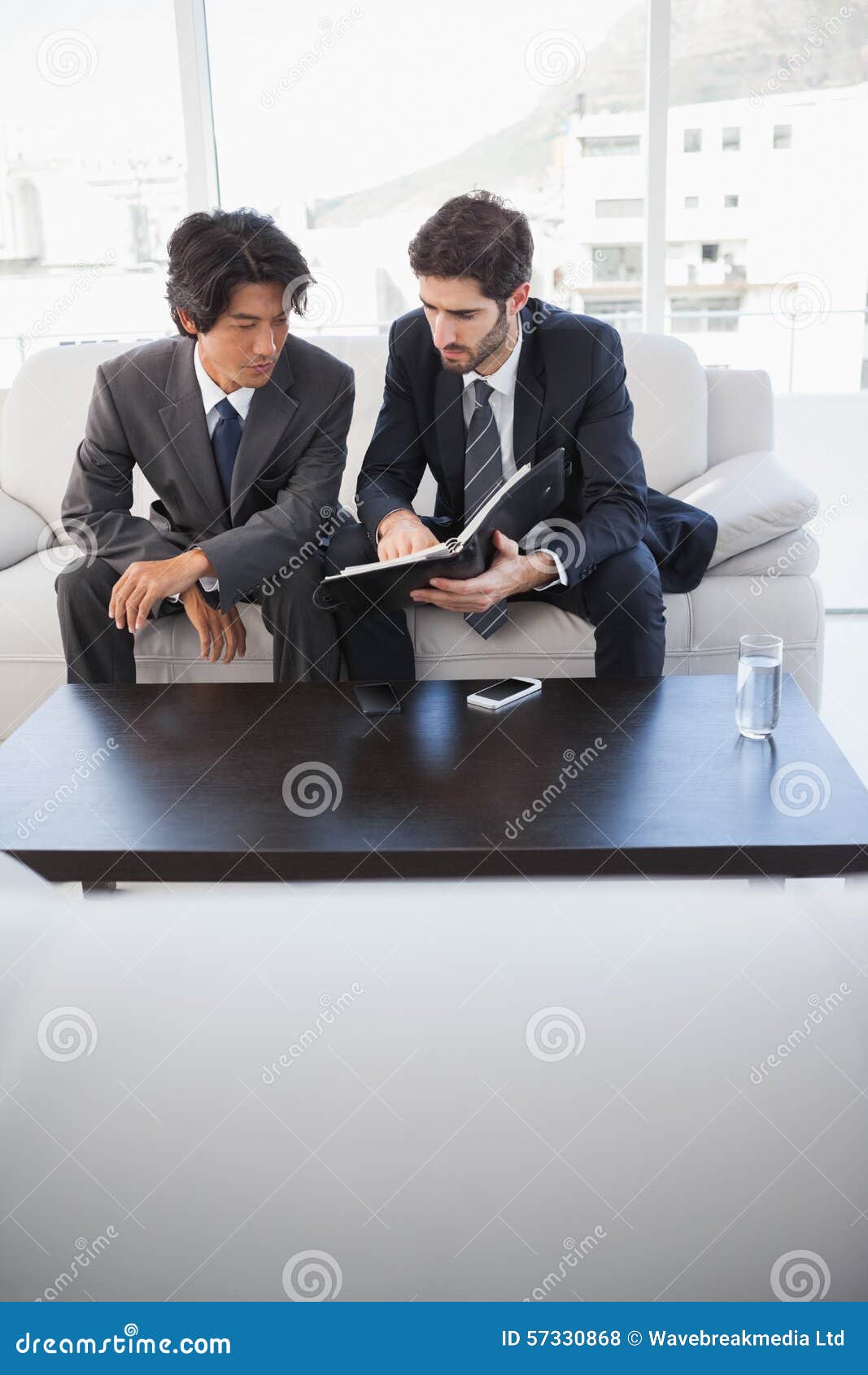Businessmen Sitting on Couch Together Stock Photo - Image of looking ...