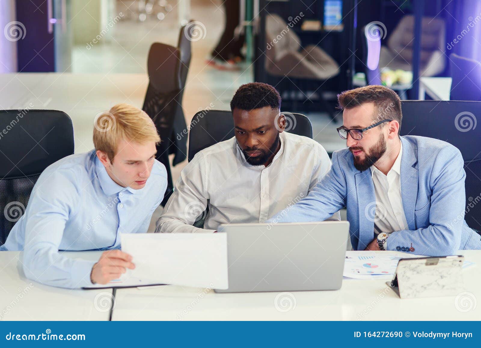 Businessmen Sitting at the Office Table and Comparing Data from Report ...