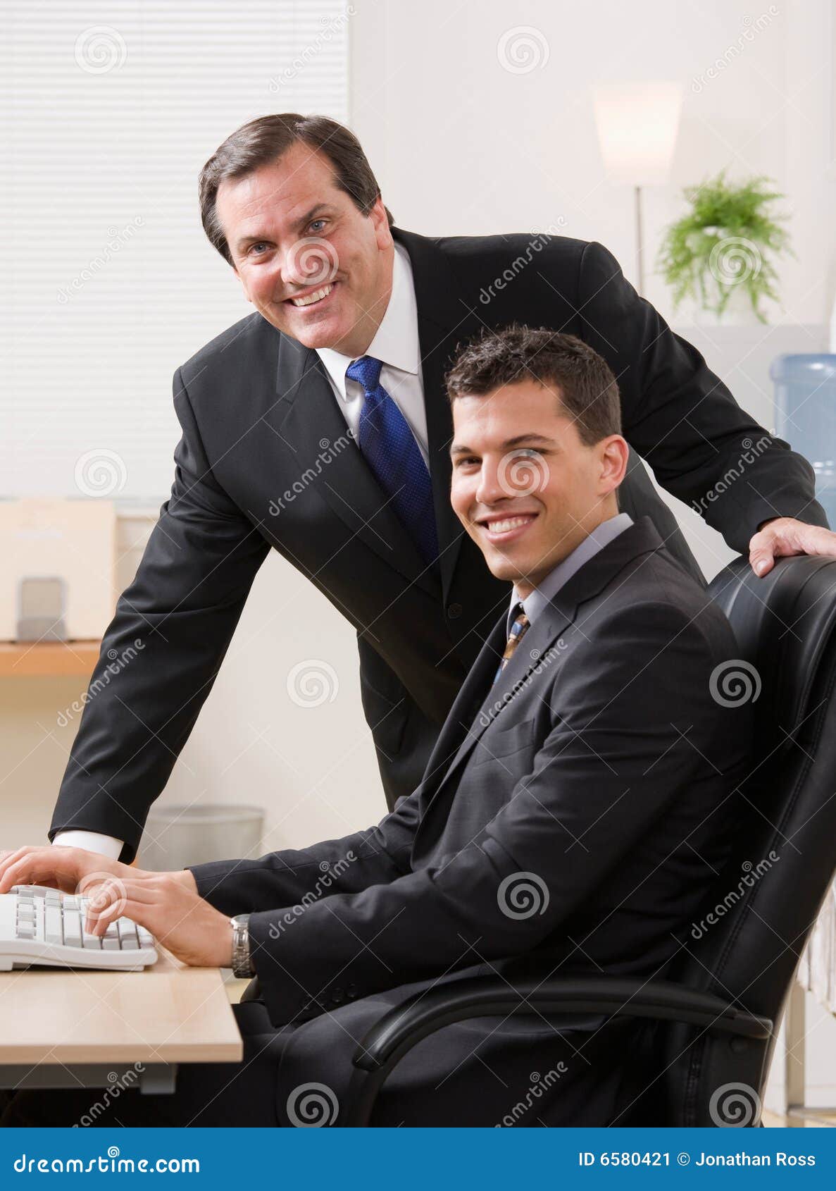 Businessmen Smiling at Desk in Office Stock Image - Image of male ...