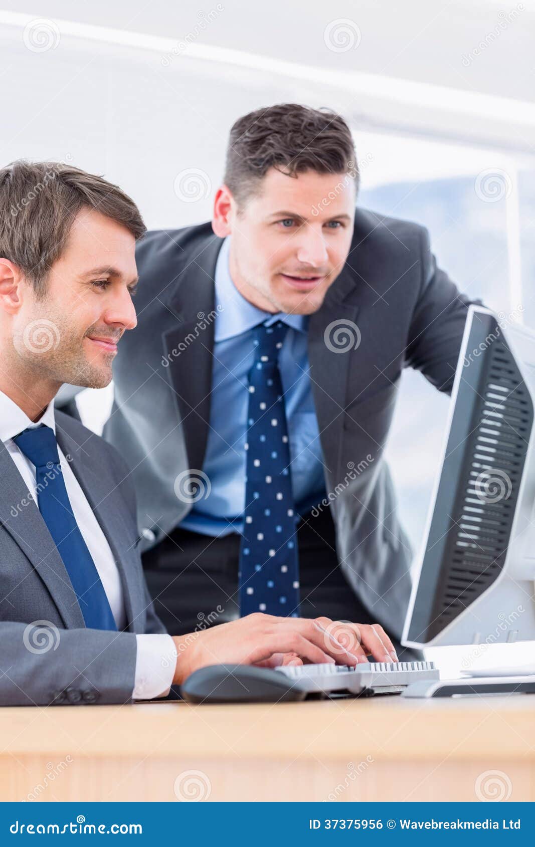 Businessmen Using Computer at Office Desk Stock Photo - Image of ...
