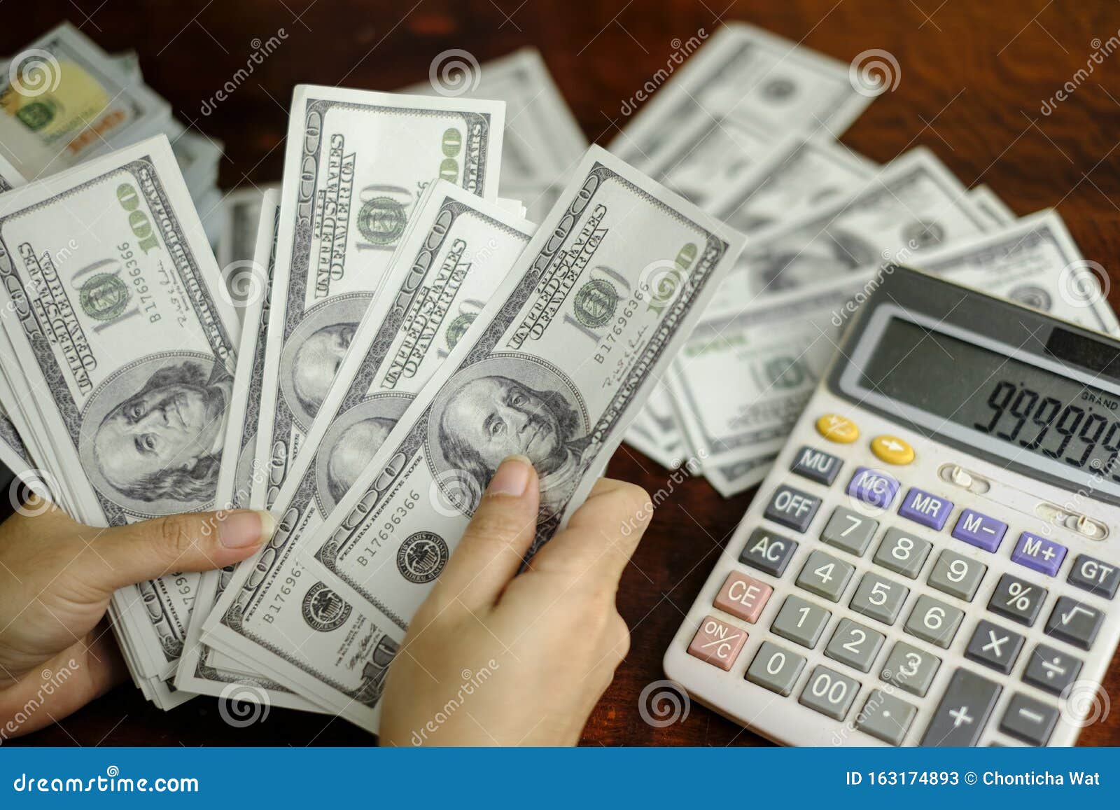 Businessmen Counting Money on a Stack of 100 US Dollars Banknotes Stock ...