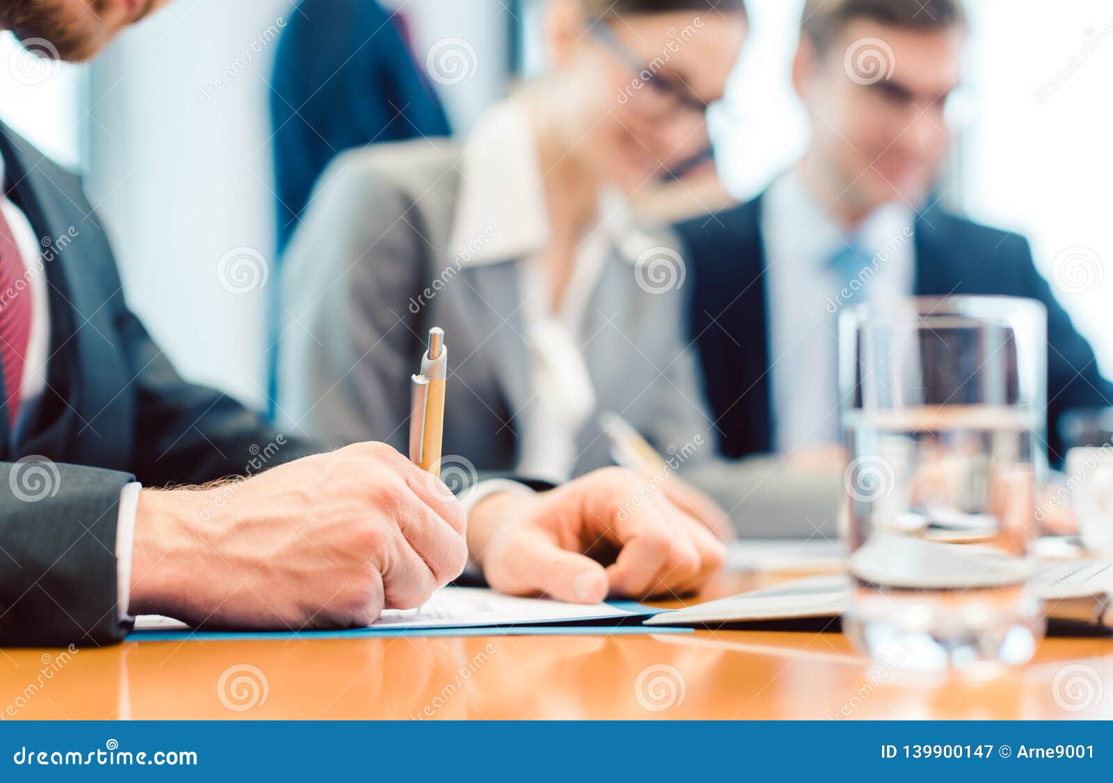 Businesspeople Analyzing Documents or Reading a Contract Stock Image ...