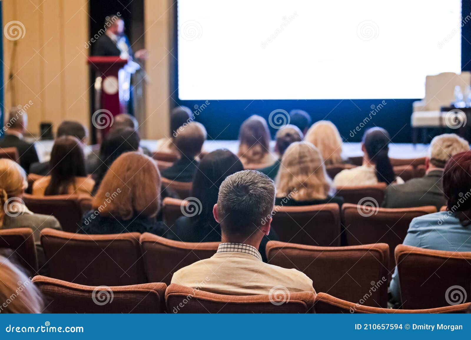 Male Presenter Speaking in Front of the Group of People in the Hall ...
