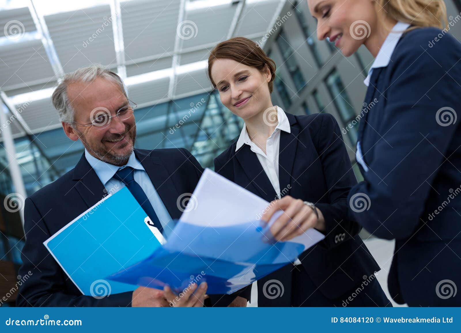 Businesspeople Discussing Over Documents Stock Photo - Image of elegant ...