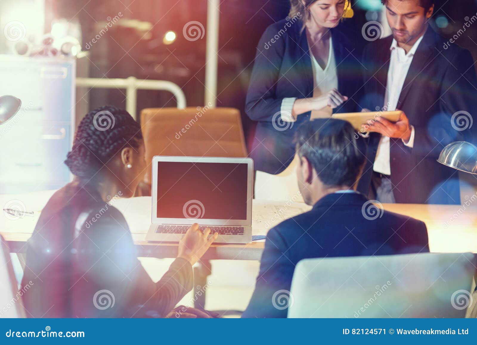 Businesspeople Discussing Over Laptop and Digital Tablet Stock Image ...
