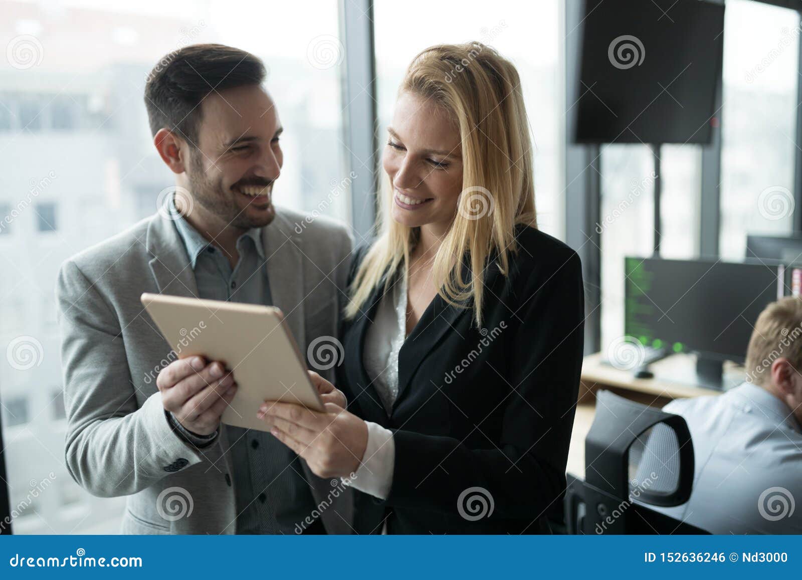 Businesspeople Discussing while Using Digital Tablet in Office Stock ... Businesspeople Discussing while Using Digital Tablet in Office Stock ...