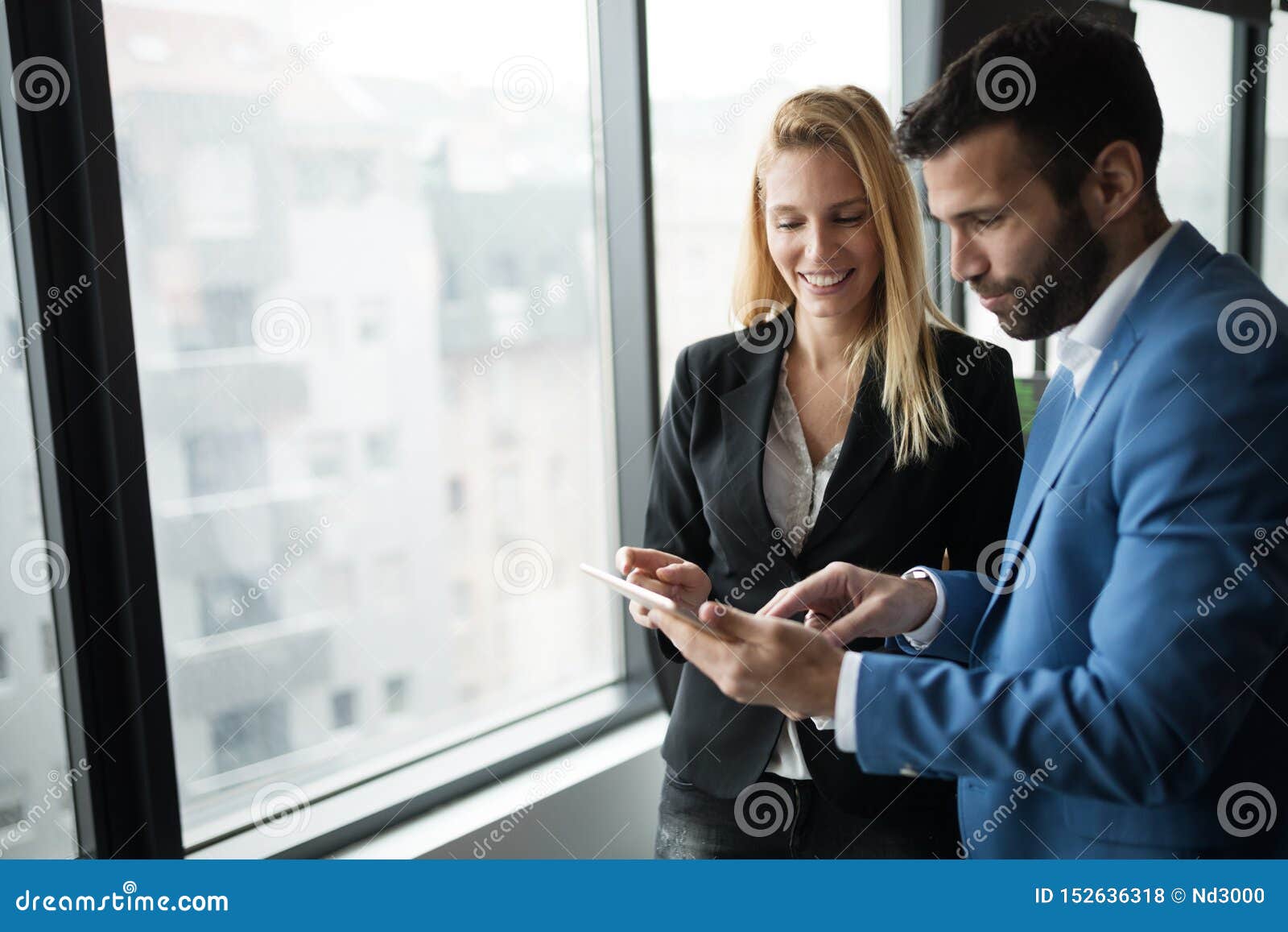 Businesspeople Discussing while Using Digital Tablet in Office Stock ...