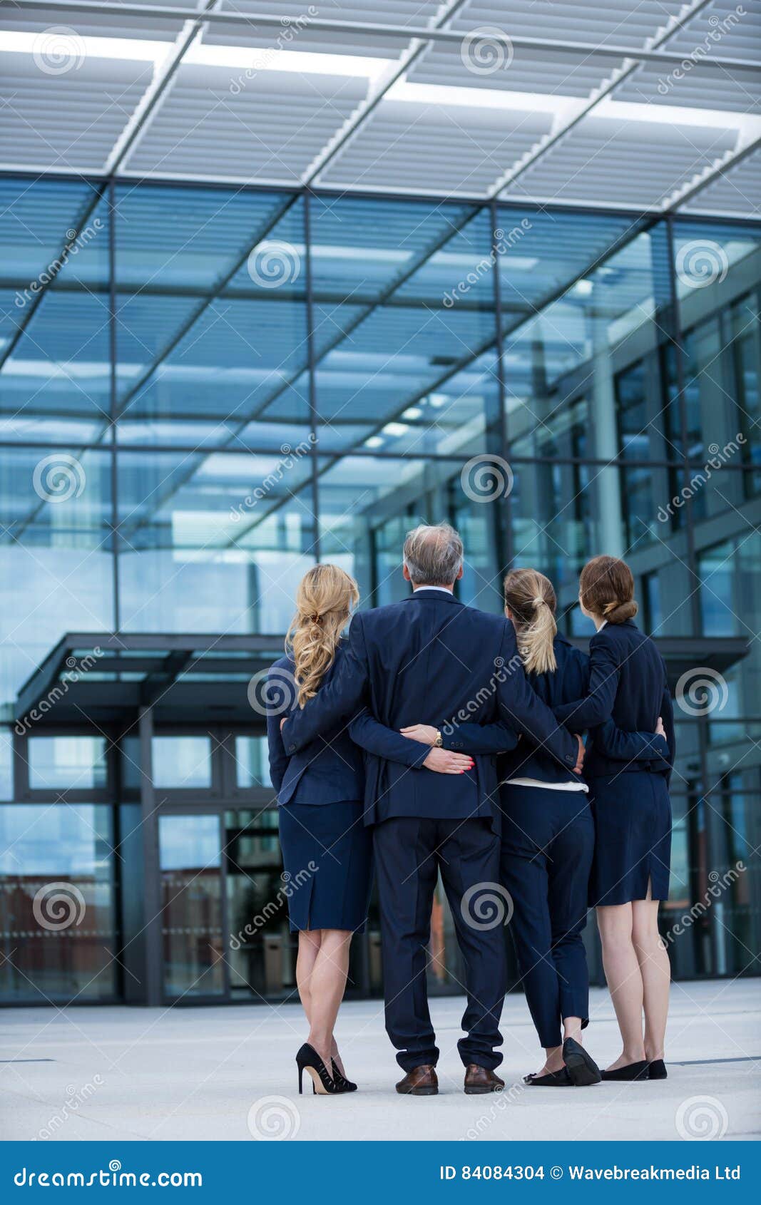 Businesspeople Forming a Huddle in Office Premises Stock Photo - Image ...