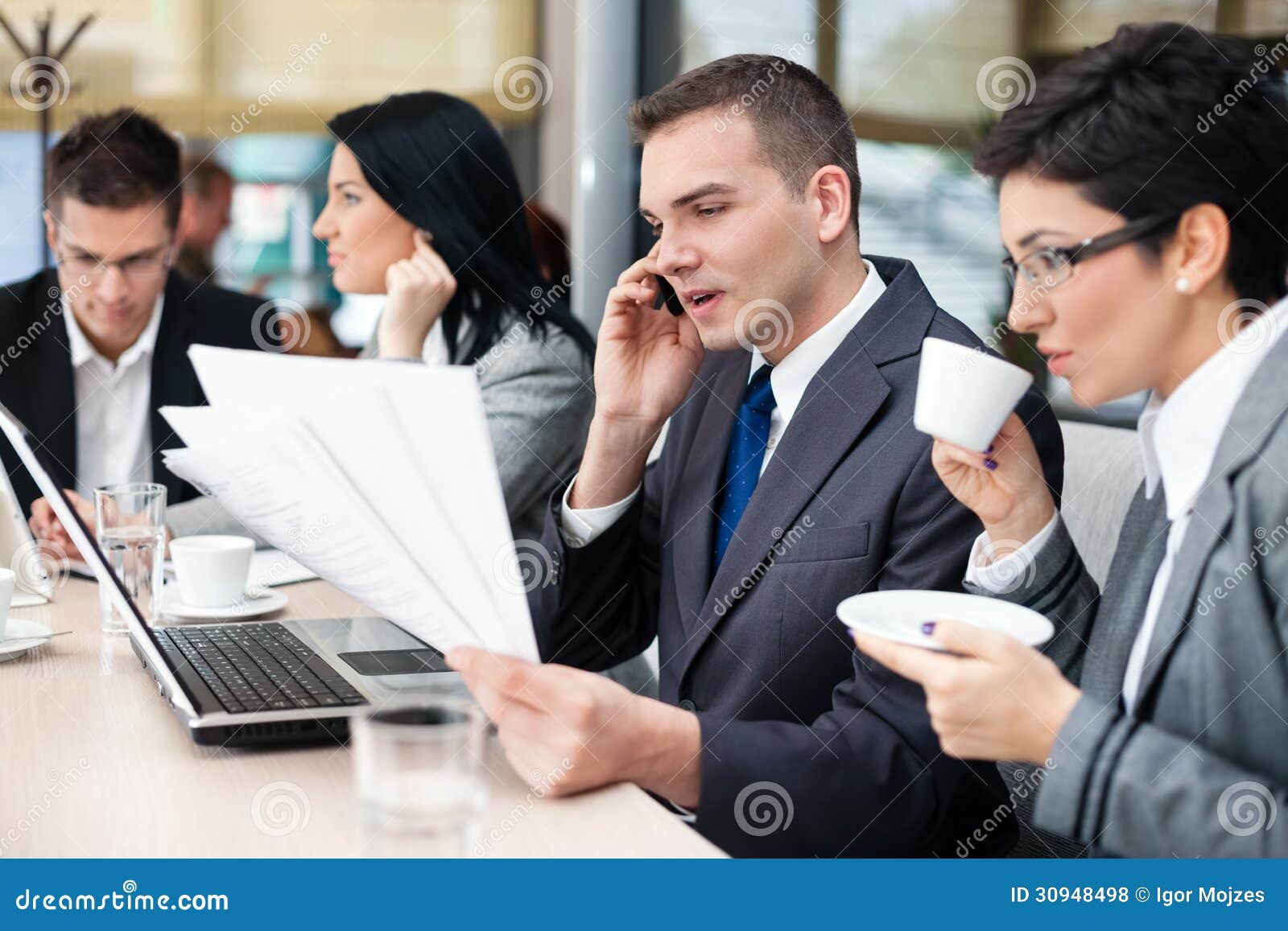 Businesspeople Having a Business Meeting Using Laptop Computer Stock ...