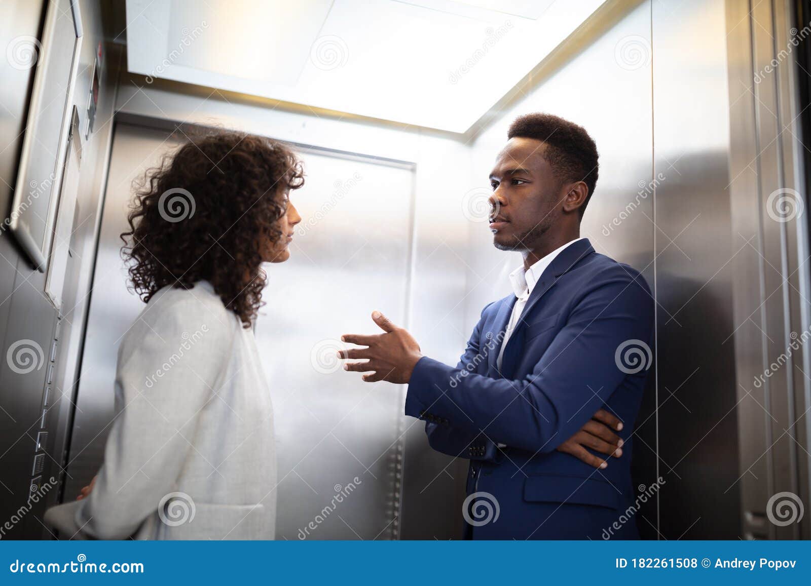 Businesspeople Having Conversation in Elevator Stock Photo - Image of ...
