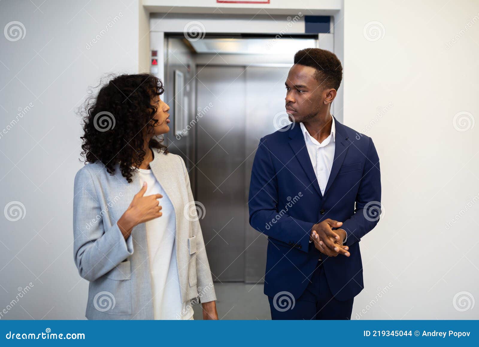 Businesspeople Having Conversation in Elevator Stock Photo - Image of ...