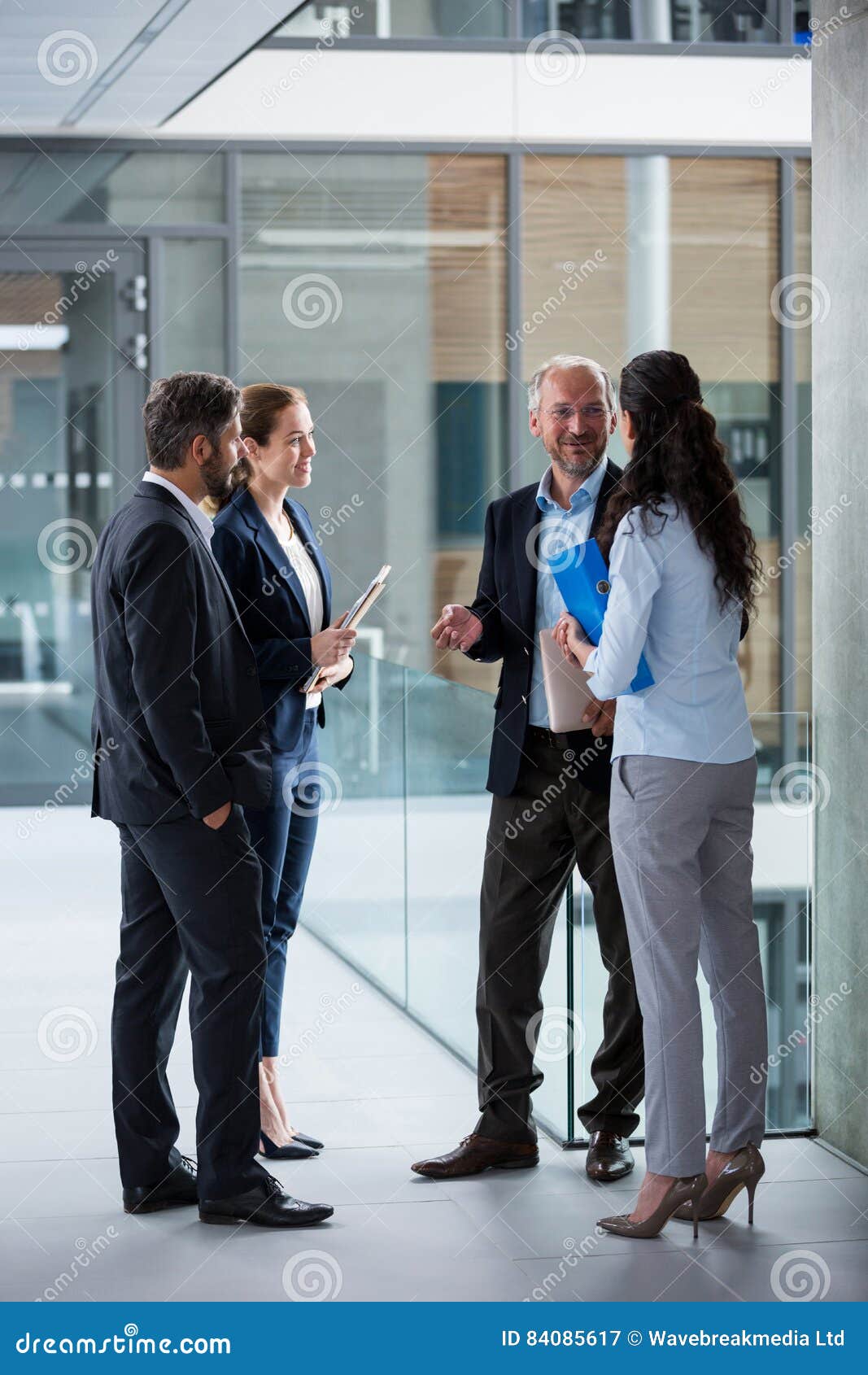 Businesspeople Having a Discussion in Office Corridor Stock Image ...