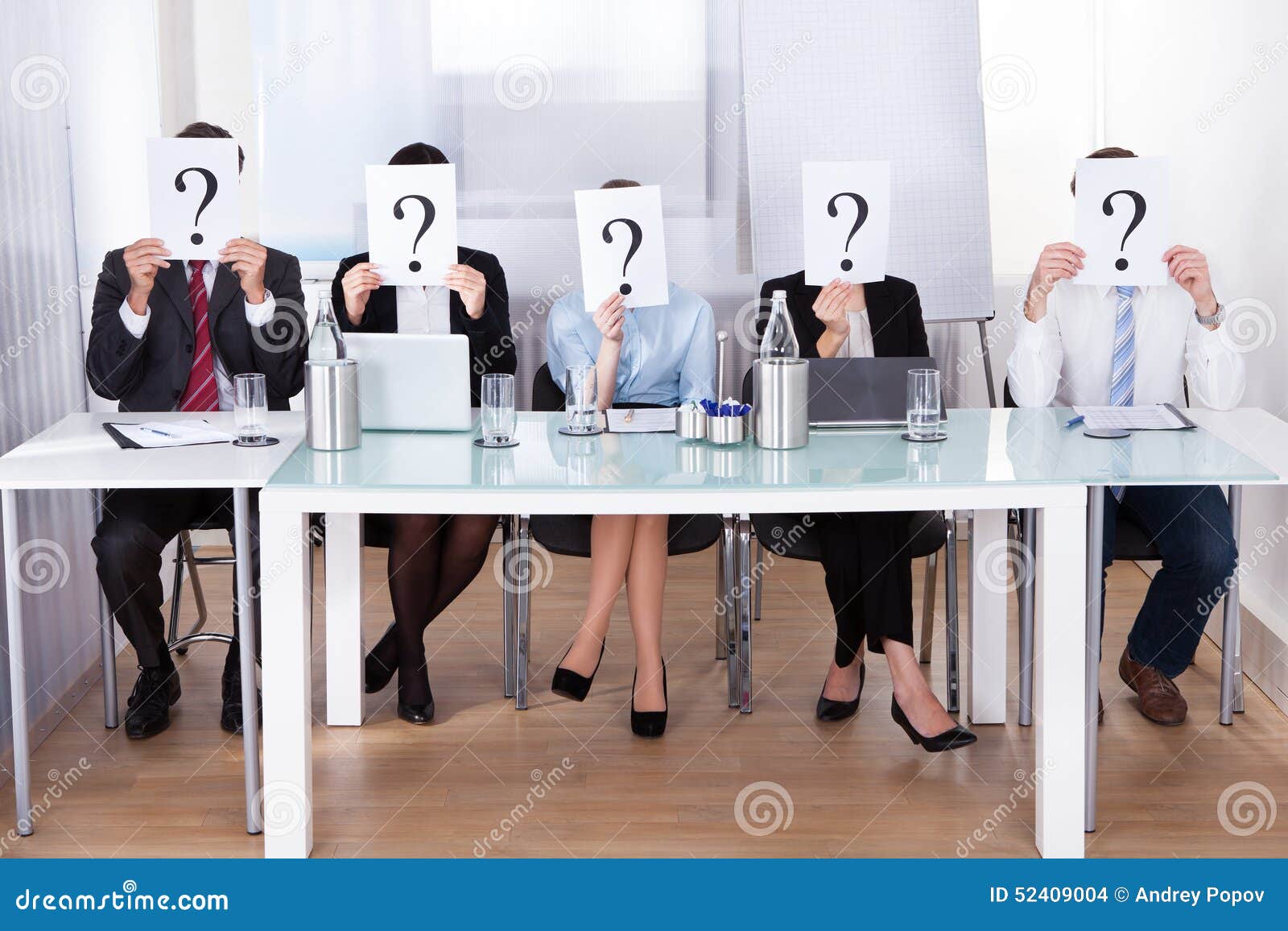 Businesspeople Holding Question Mark in Front of Face Stock Photo ...