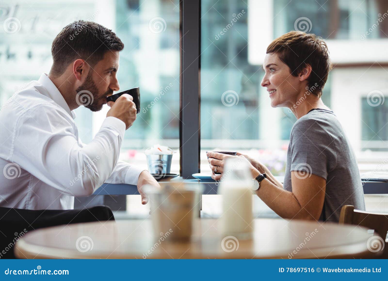 Businesspeople Interacting while Having Coffee Stock Photo - Image of ...