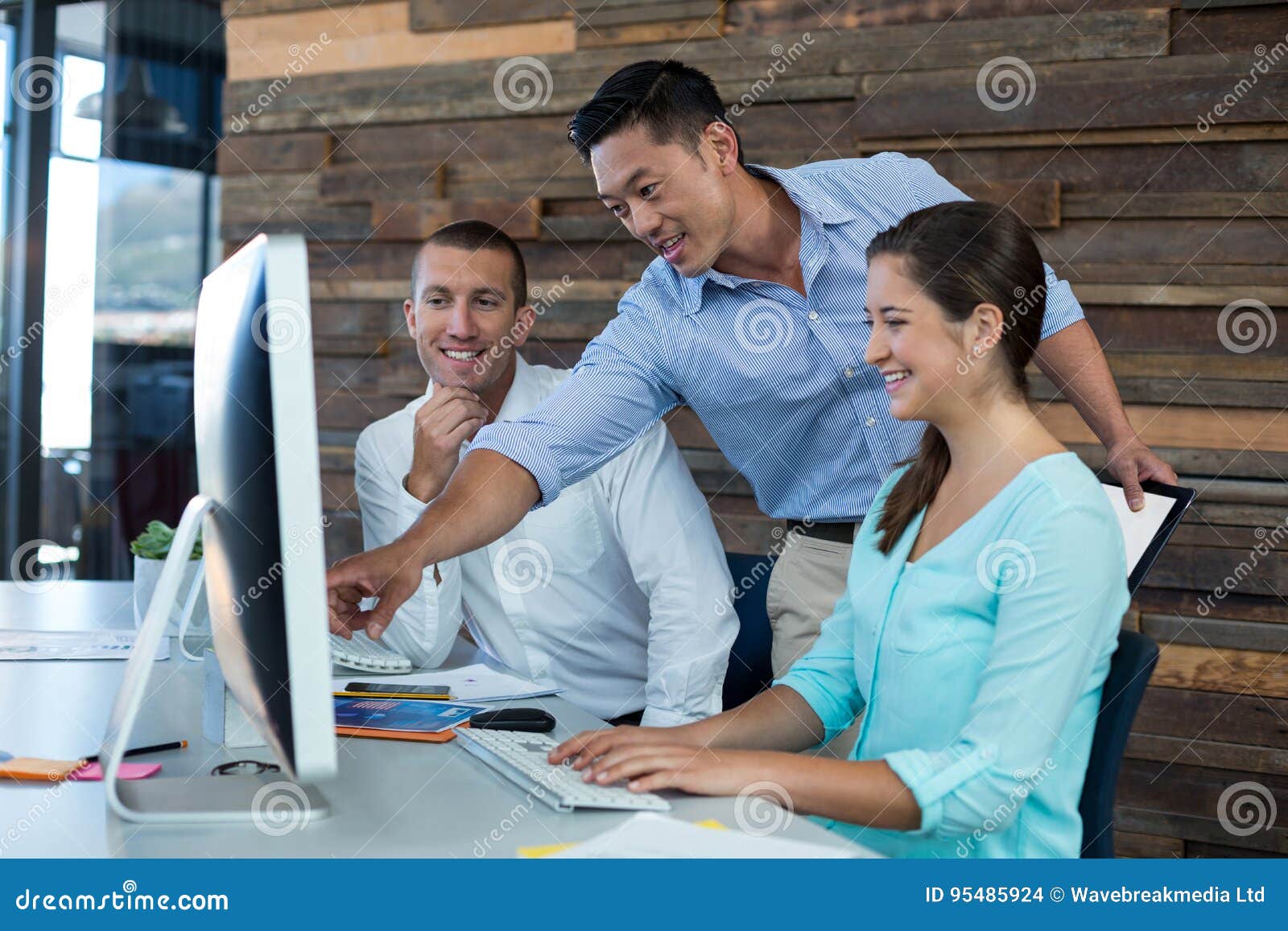 Businesspeople Interacting while Working on Personal Computer Stock ...