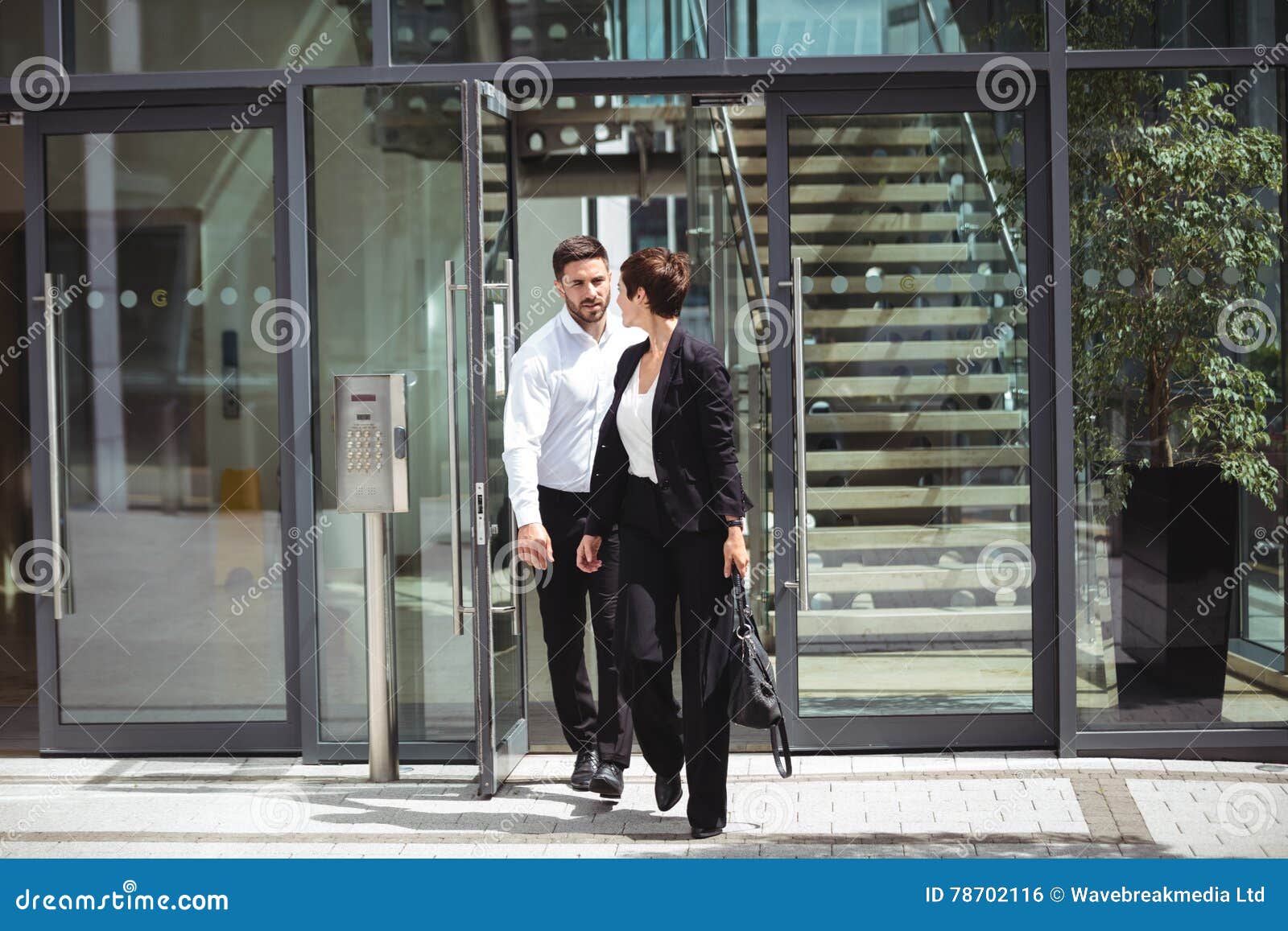 Businesspeople Leaving Office Stock Photo - Image of colleague ...