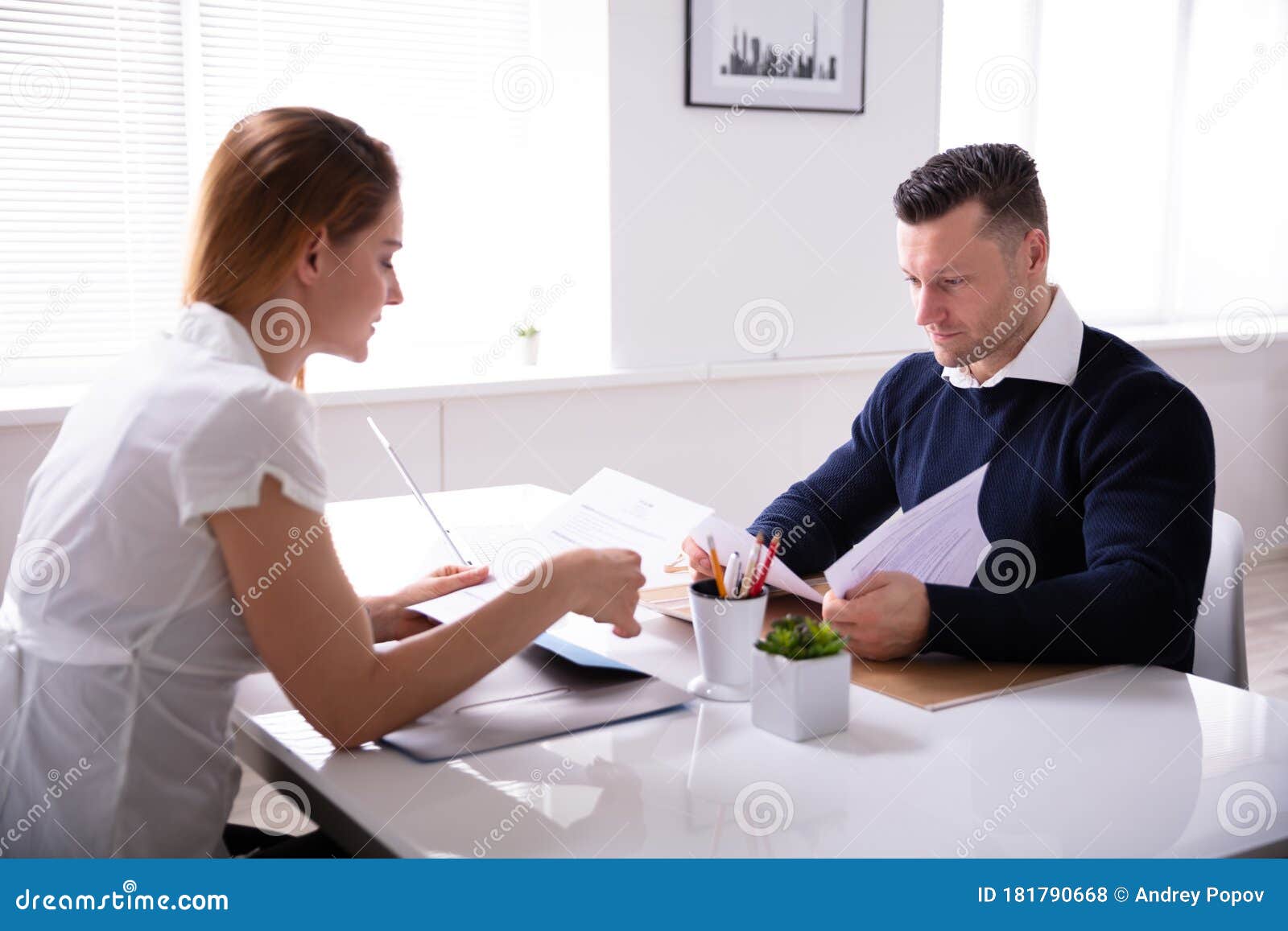 Businesspeople Looking at Document while Interview Stock Photo - Image ...