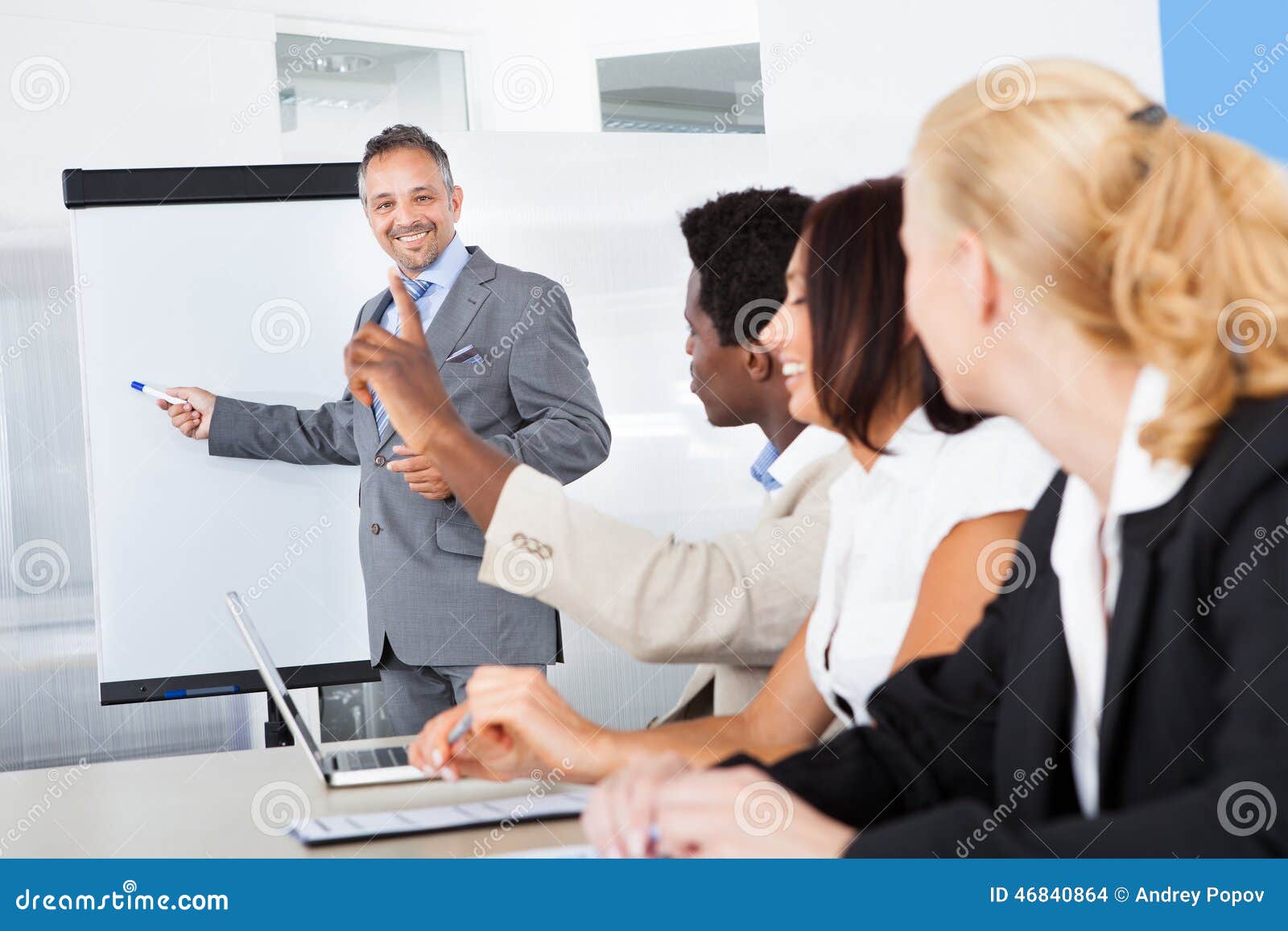 Businesspeople Looking at Man Explaining Stock Photo - Image of ethnic ...