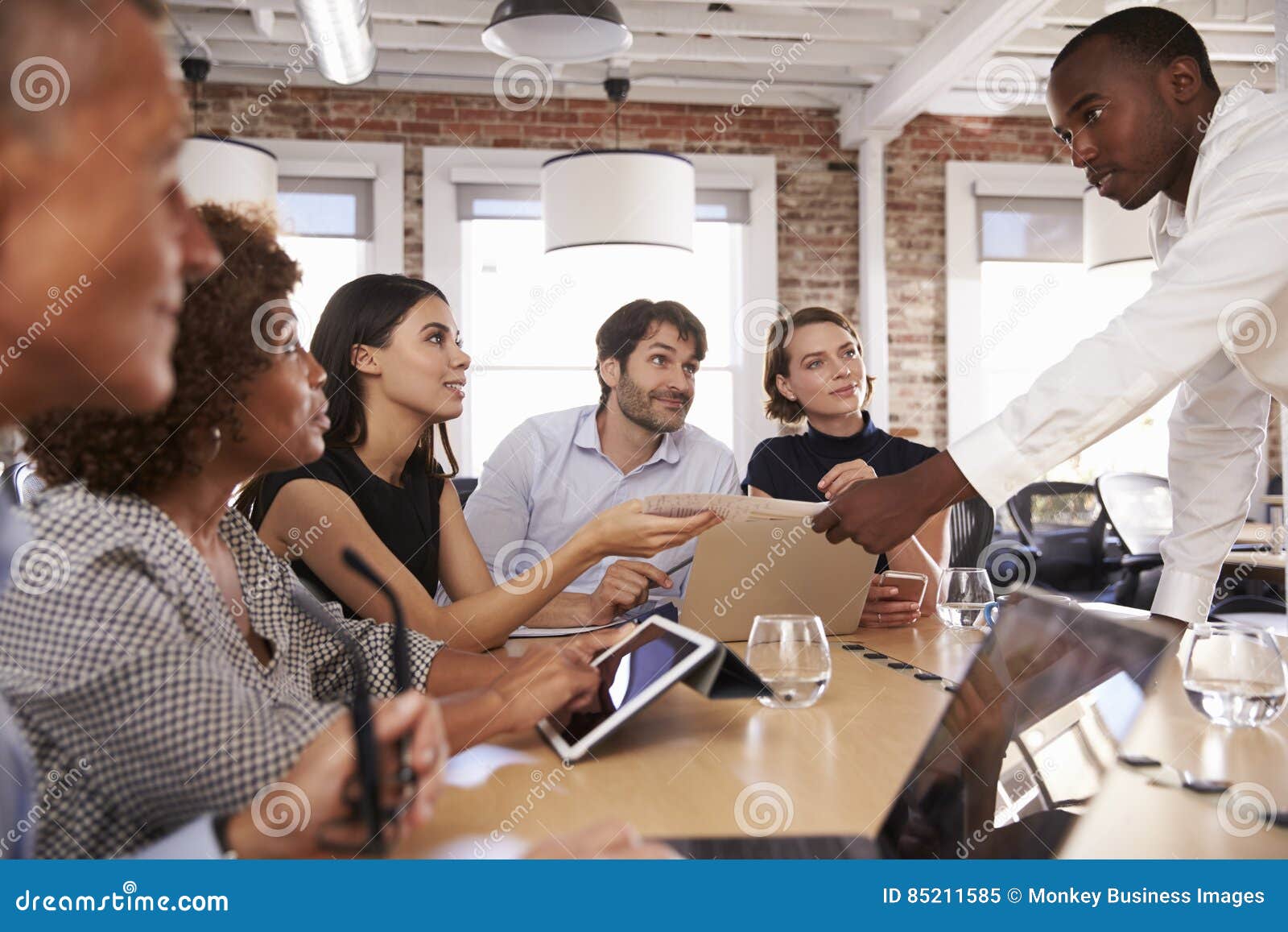 Businesspeople Meeting Around Table in Modern Office Stock Image ...