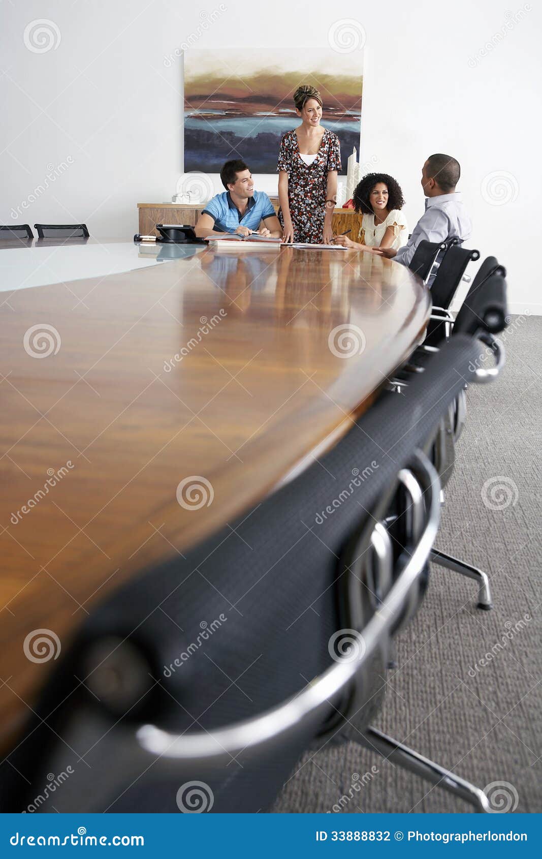 Businesspeople in Meeting at End of Conference Table Stock Photo ...