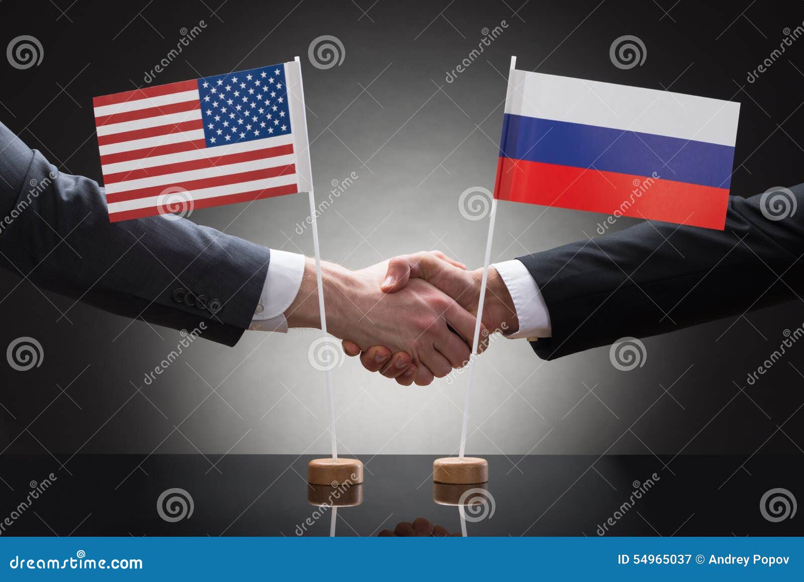 Businesspeople Shaking Hands with Us and Russia Flags Stock Image ...