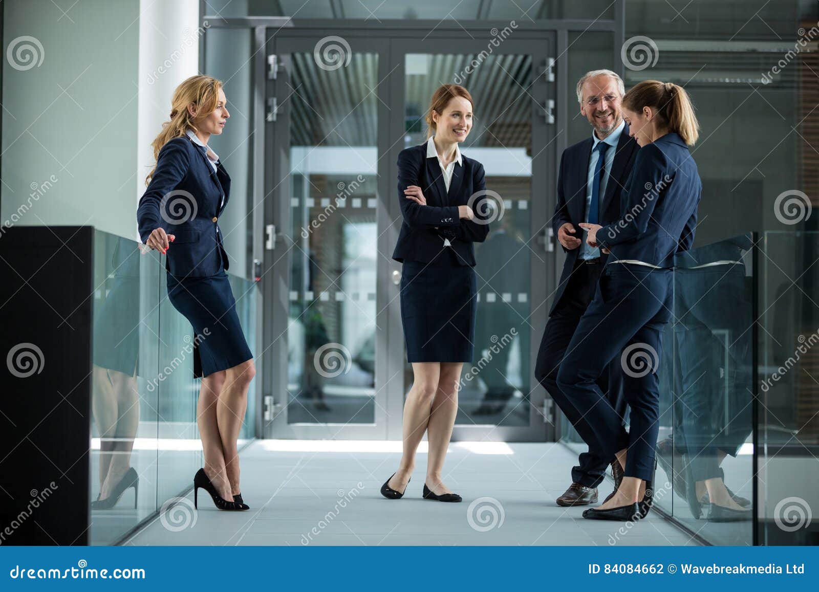 Businesspeople Standing and Having a Discussion in Office Stock Photo ...