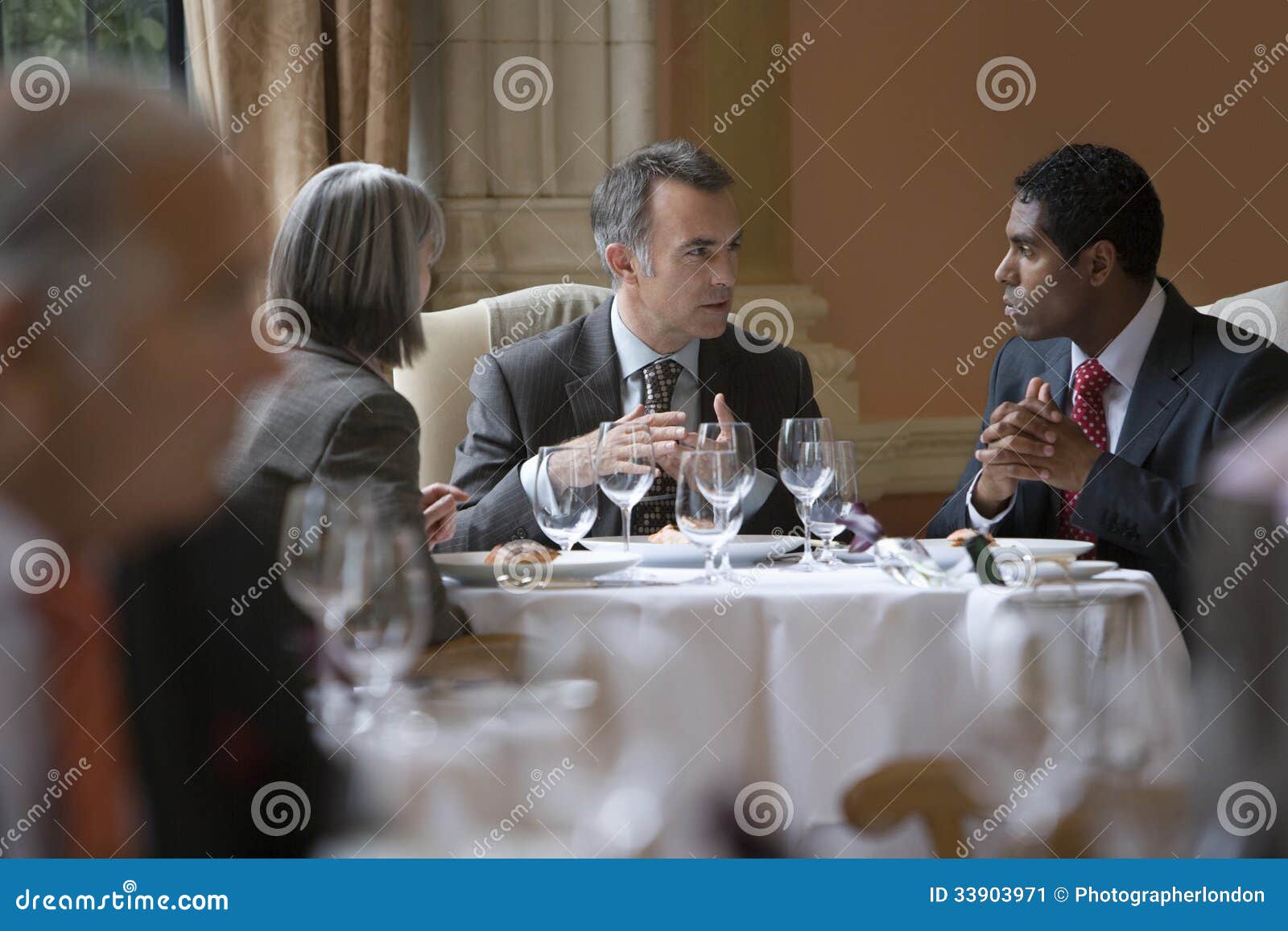 Businesspeople Talking at Restaurant Table Stock Image - Image of ...