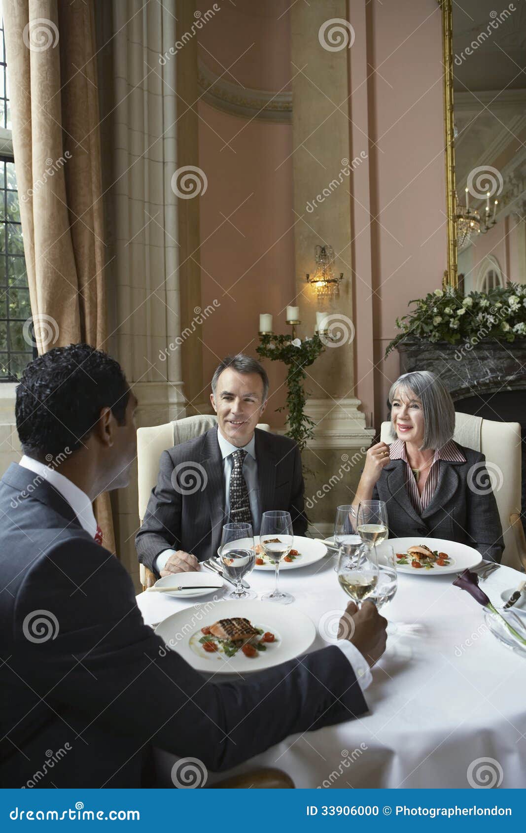 Businesspeople Talking at Restaurant Table Stock Photo - Image of ...