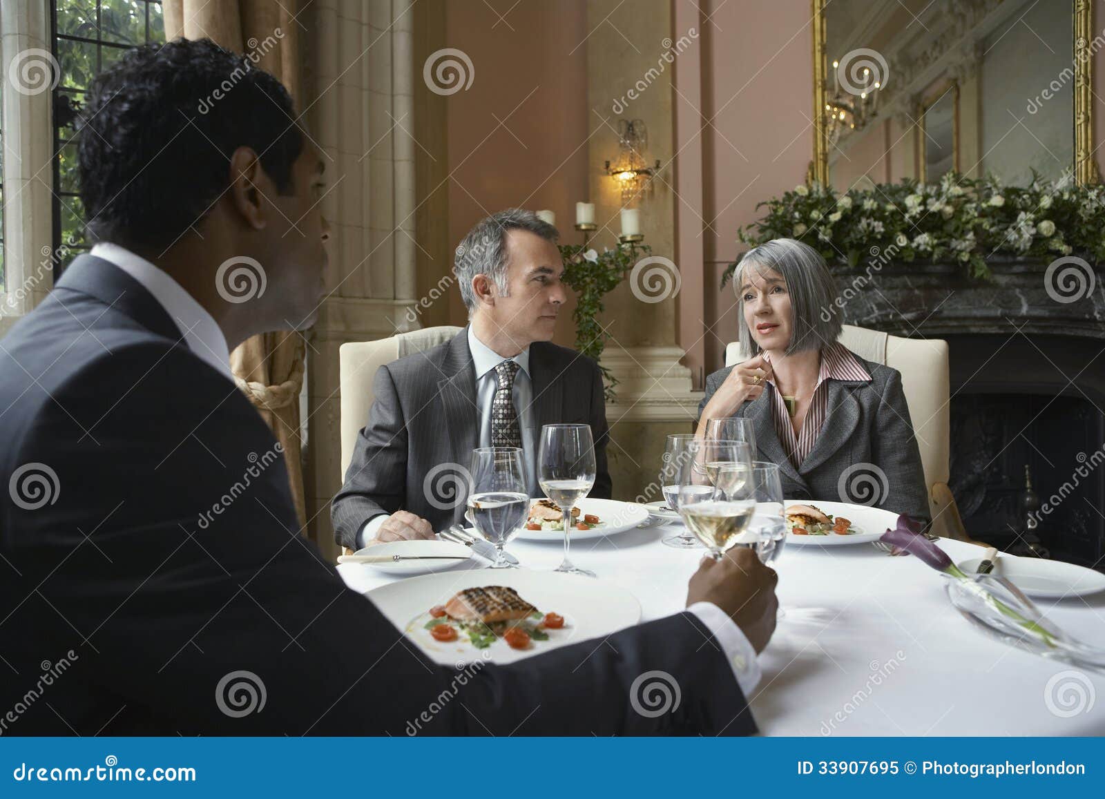Businesspeople Talking At Restaurant Table Royalty-Free Stock Photo ...