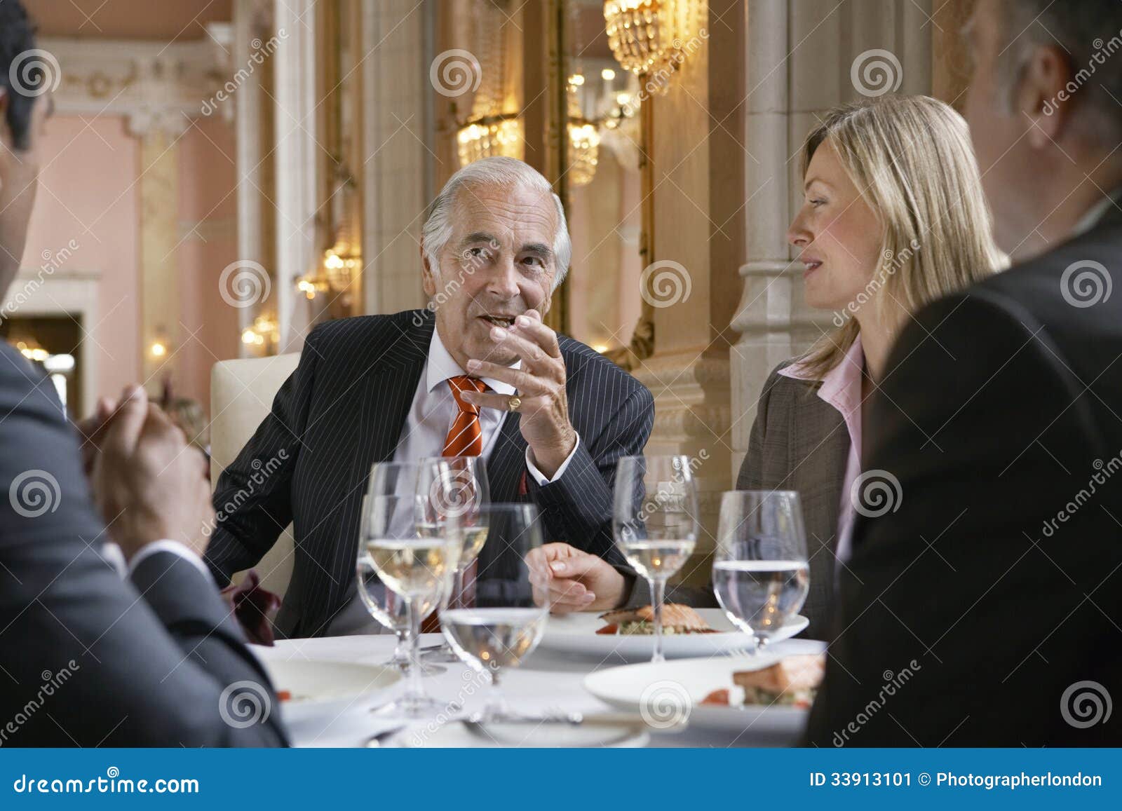 Businesspeople Talking at Restaurant Table Stock Image - Image of ...
